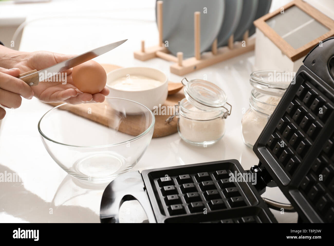 Young woman cracking egg food hi-res stock photography and images - Alamy