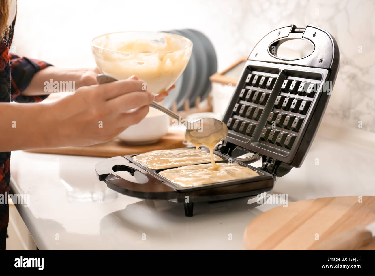 Woman preparing homemade waffles hi-res stock photography and images ...