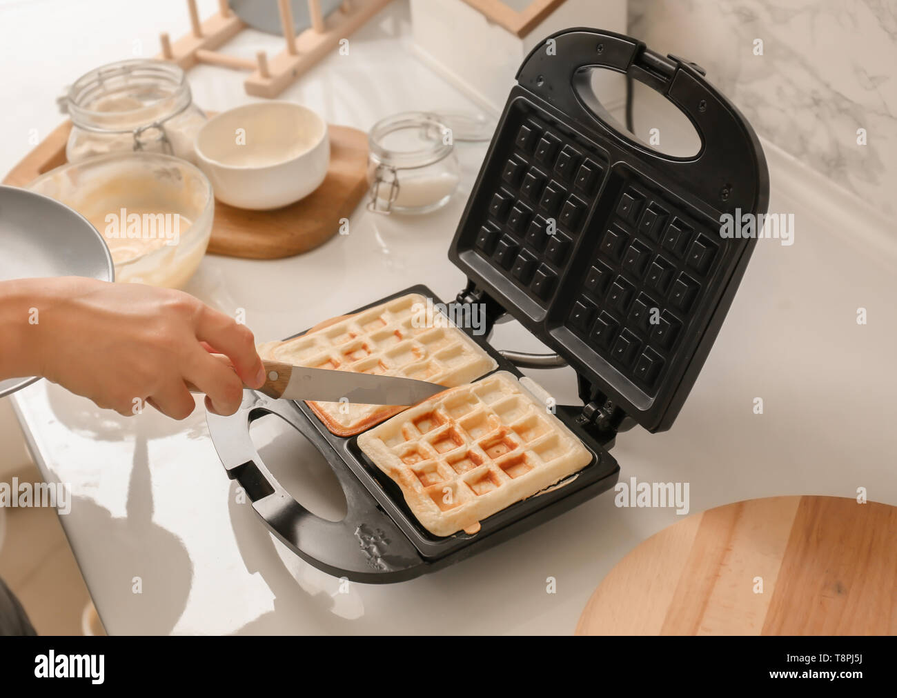 Woman preparing belgian waffle hi-res stock photography and images - Alamy