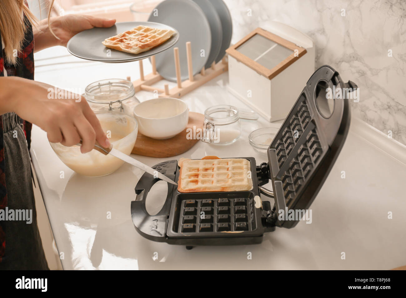 Woman preparing belgian waffle hi-res stock photography and images - Alamy