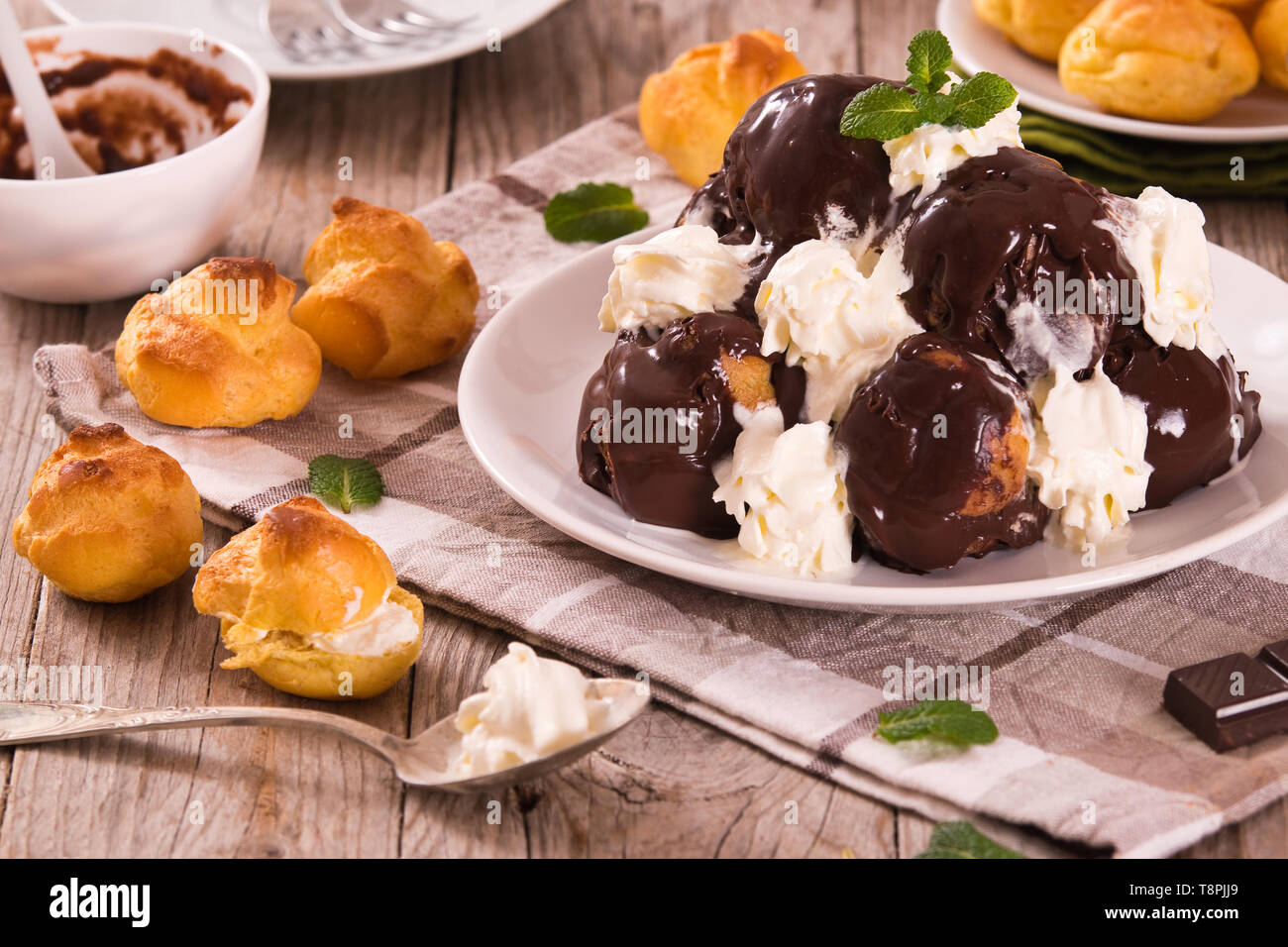 Chocolate profiteroles with chantilly cream hi-res stock photography ...