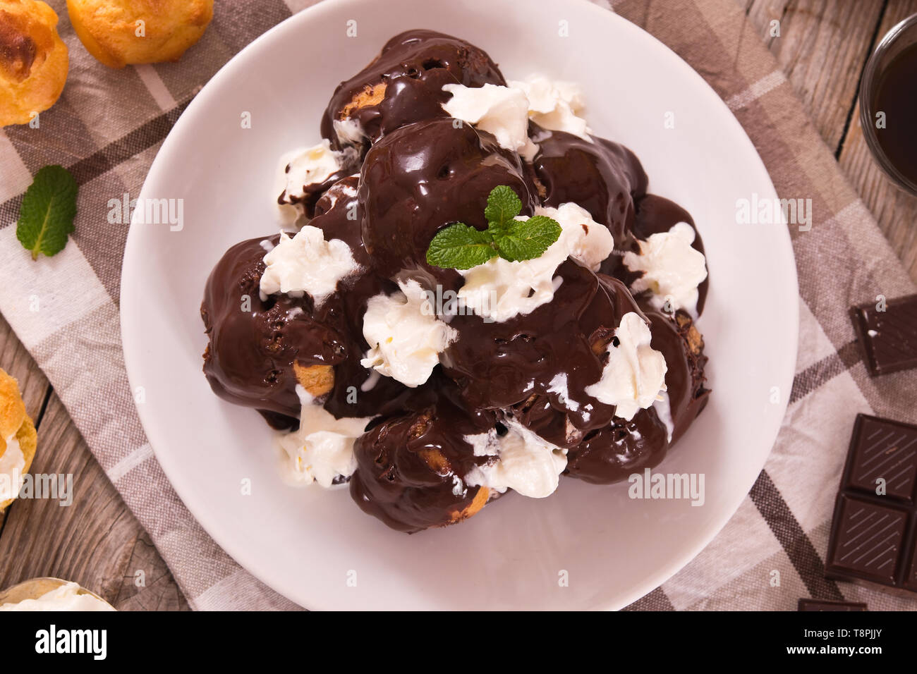 Chocolate profiteroles with chantilly cream hi-res stock photography ...