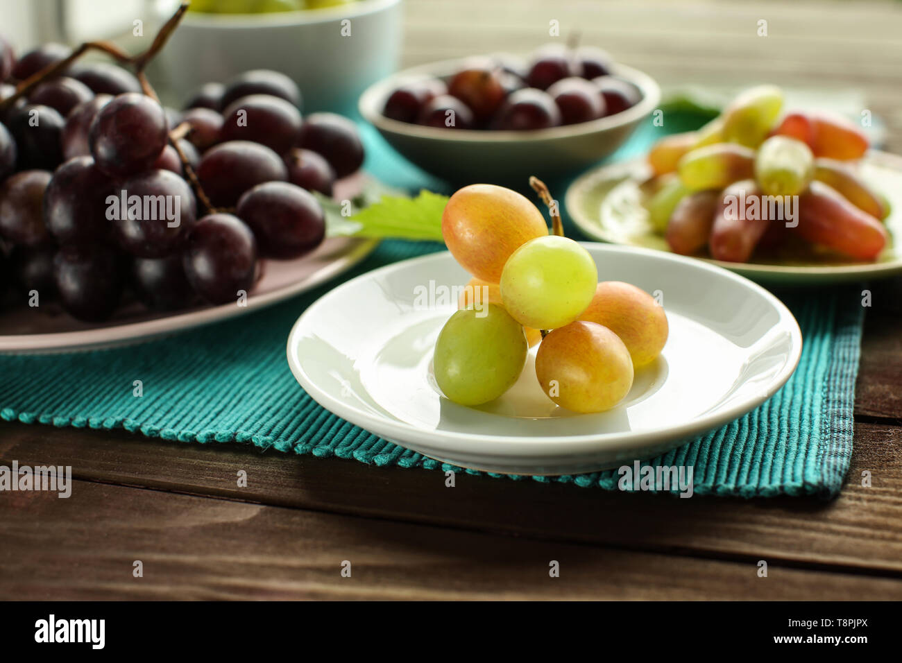 Different types of sweet grapes on table Stock Photo - Alamy