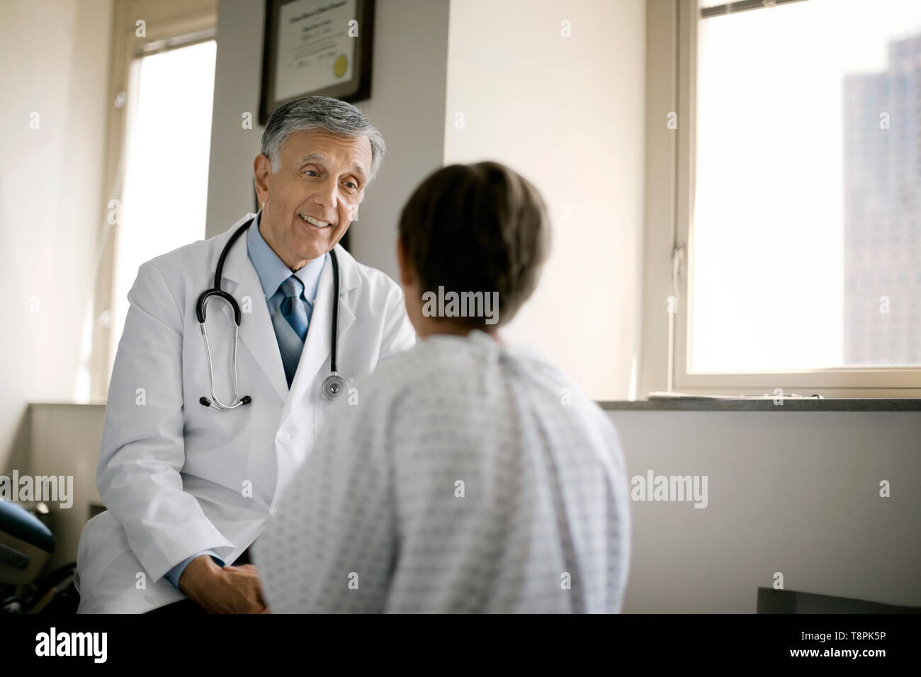 Senior doctor consulting with a patient after a medical exam Stock ...