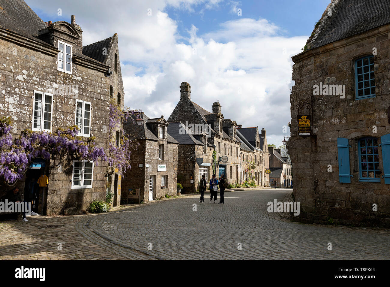 Traditional stone houses with wistaria growing on facades in preserved ...