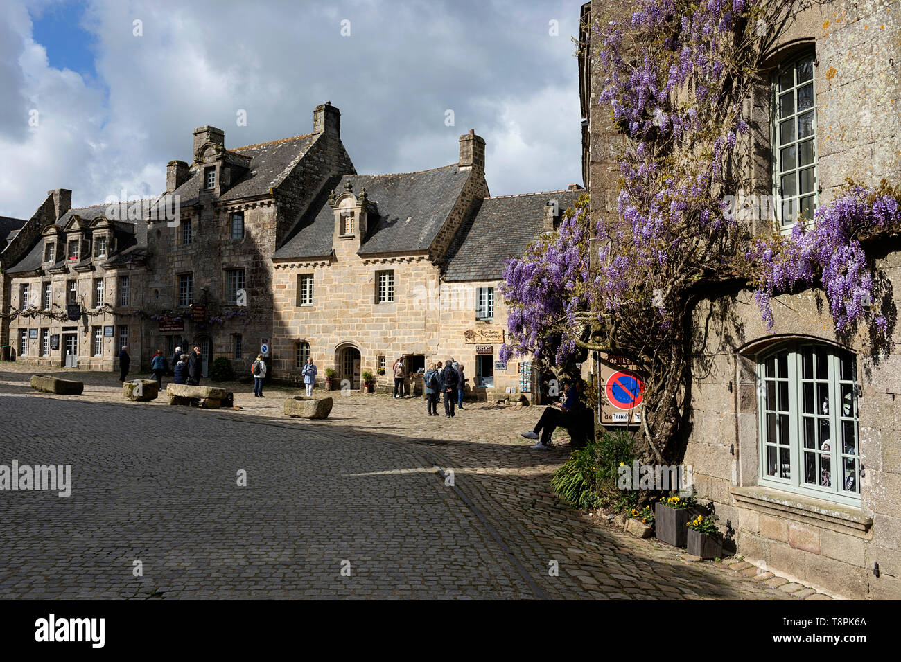 Traditional stone houses with wistaria growing on facades in preserved ...