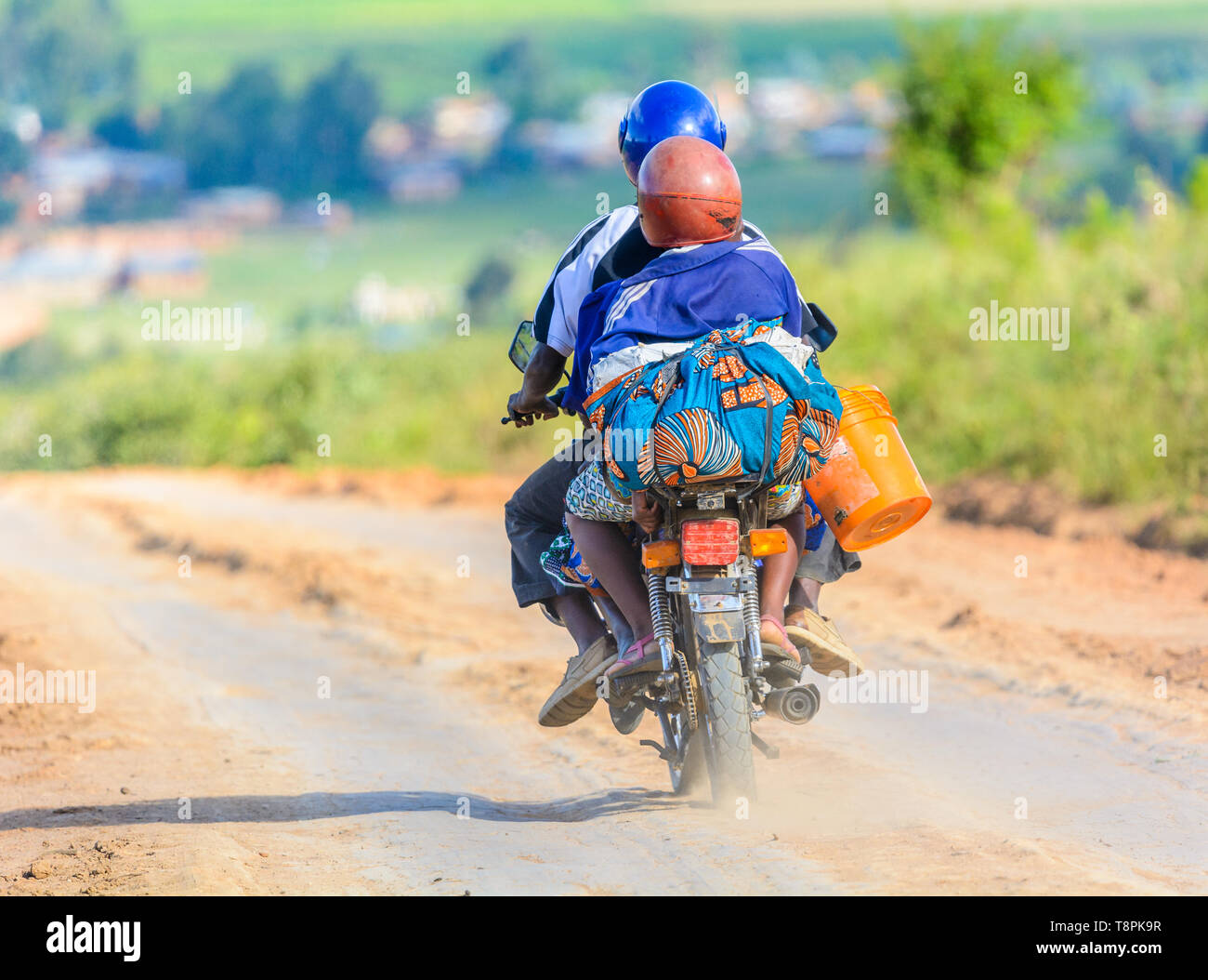 Man and his wife wearing crash helmets on a motorcycle together with ...
