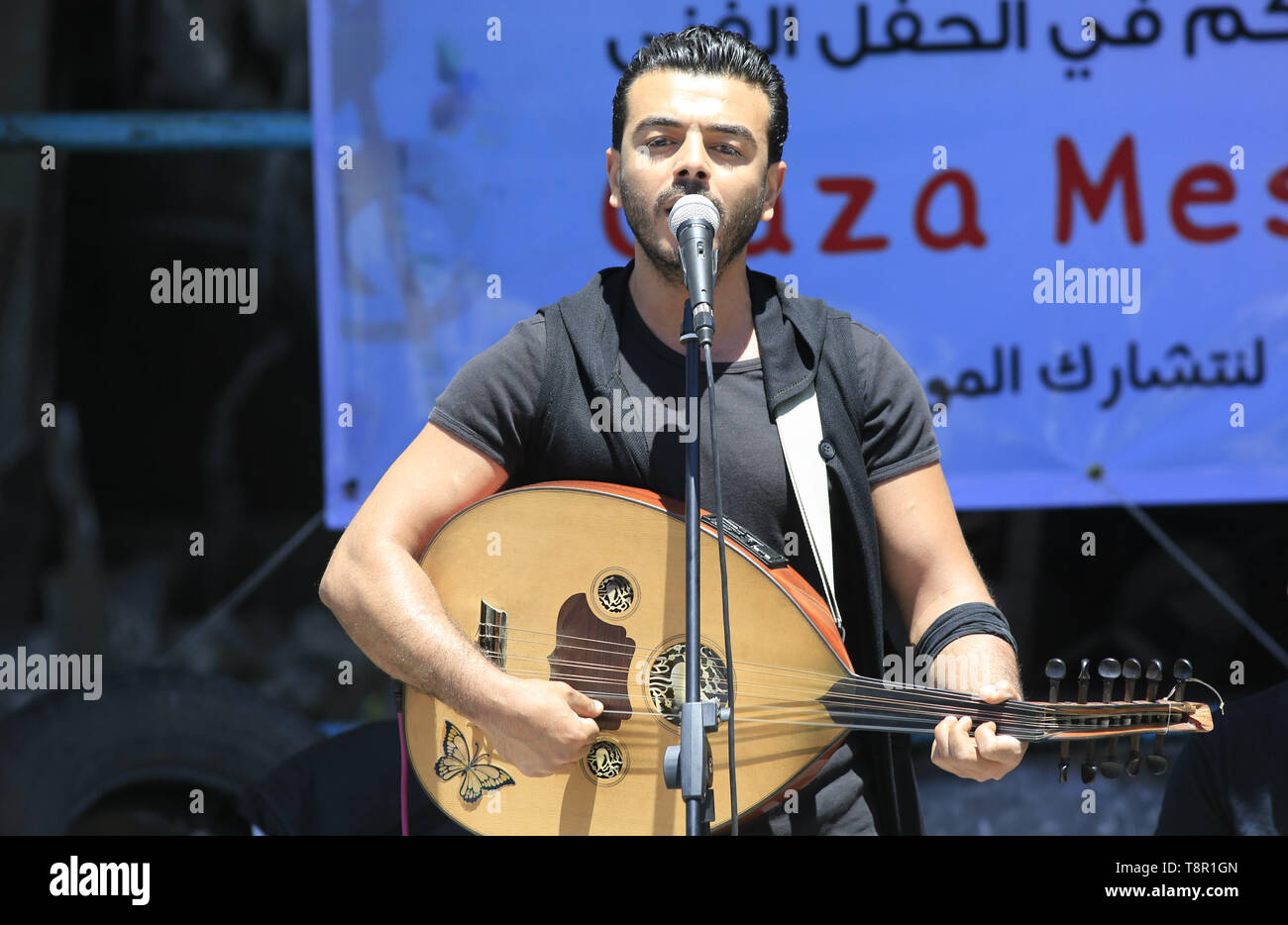 Gaza. 14th May, 2019. A Palestinian singer performs on the rubble of a ...