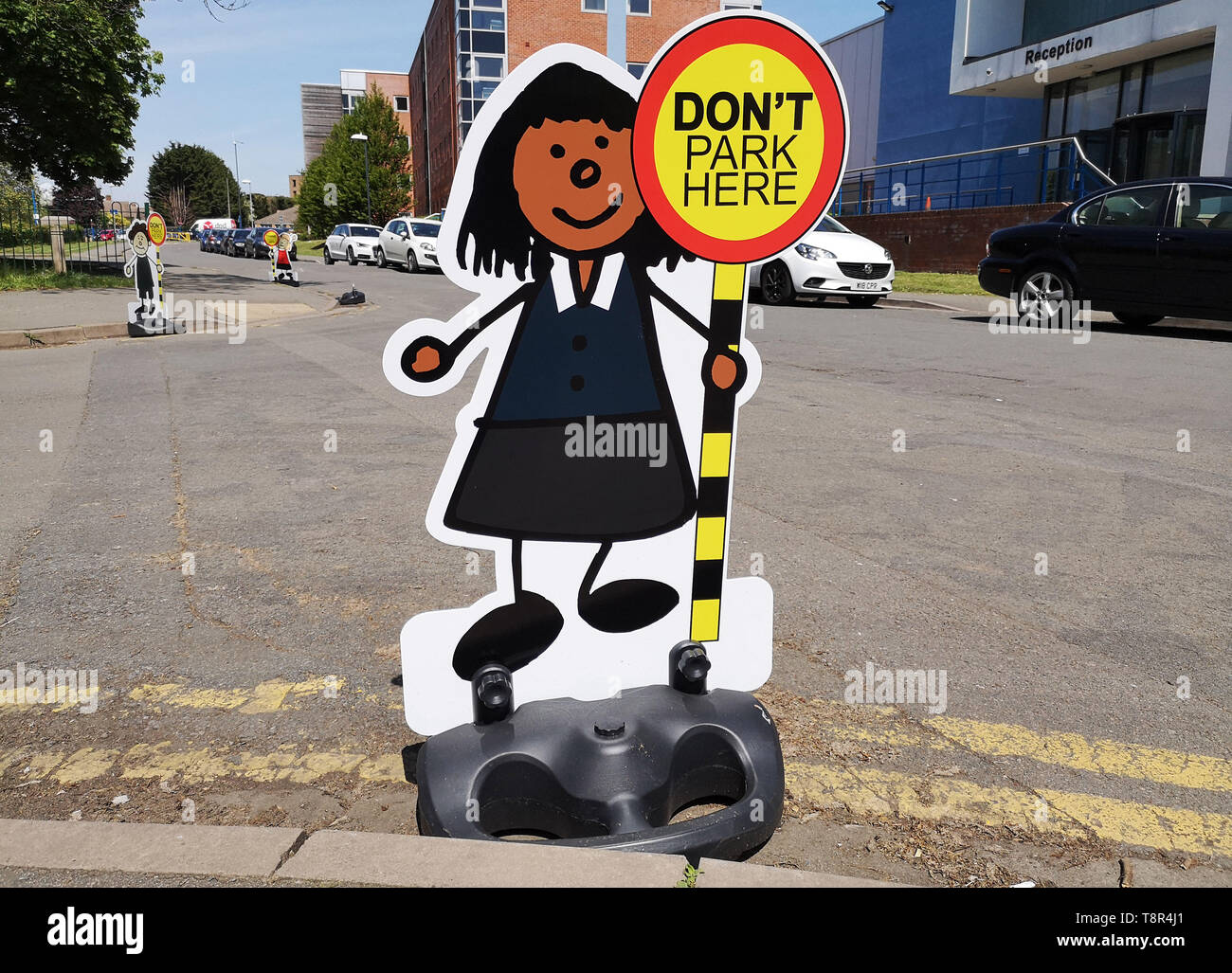 Traffic safety bollards that are drawings of small children are seen ...