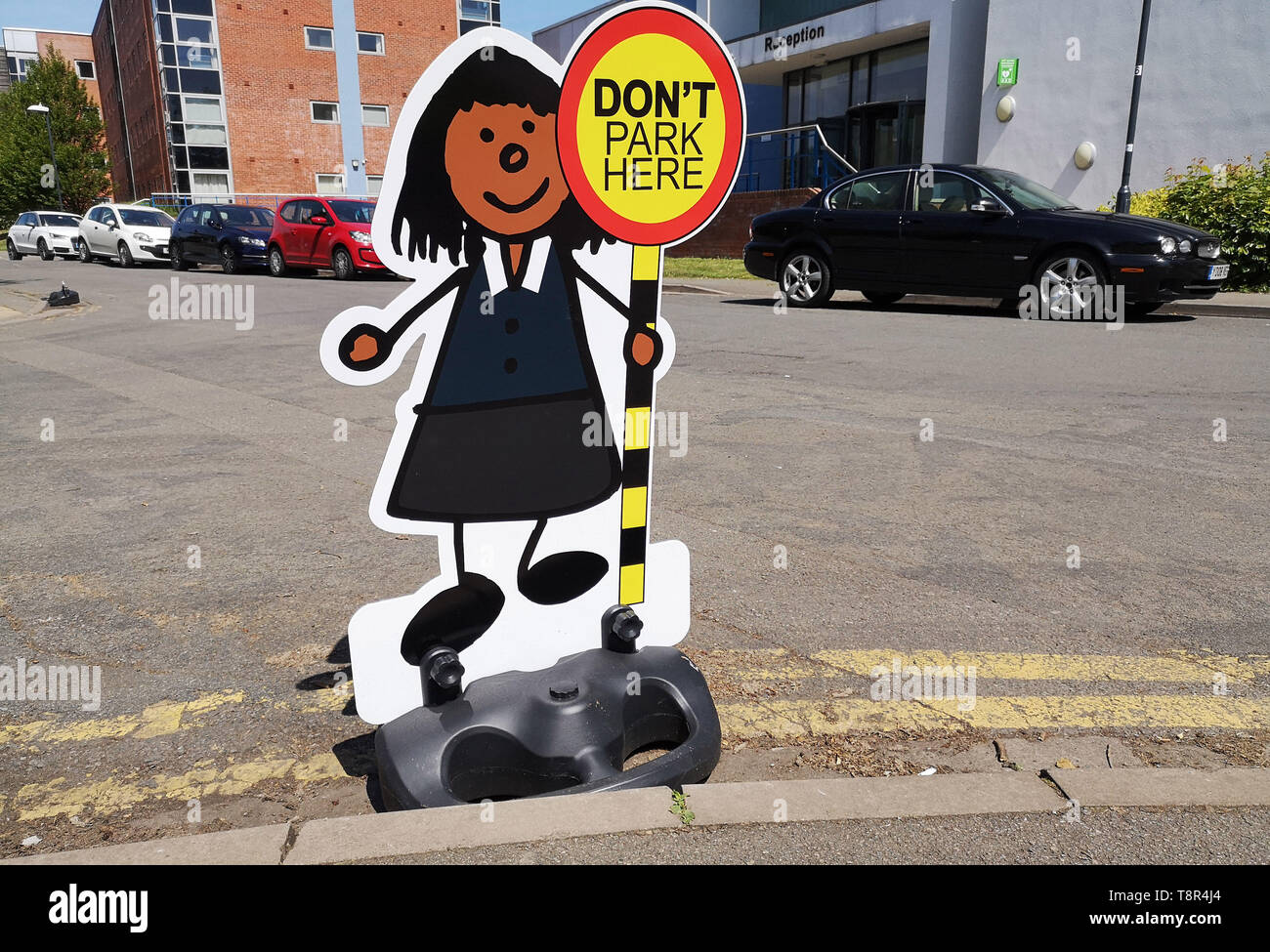Traffic safety bollards that are drawings of small children are seen ...