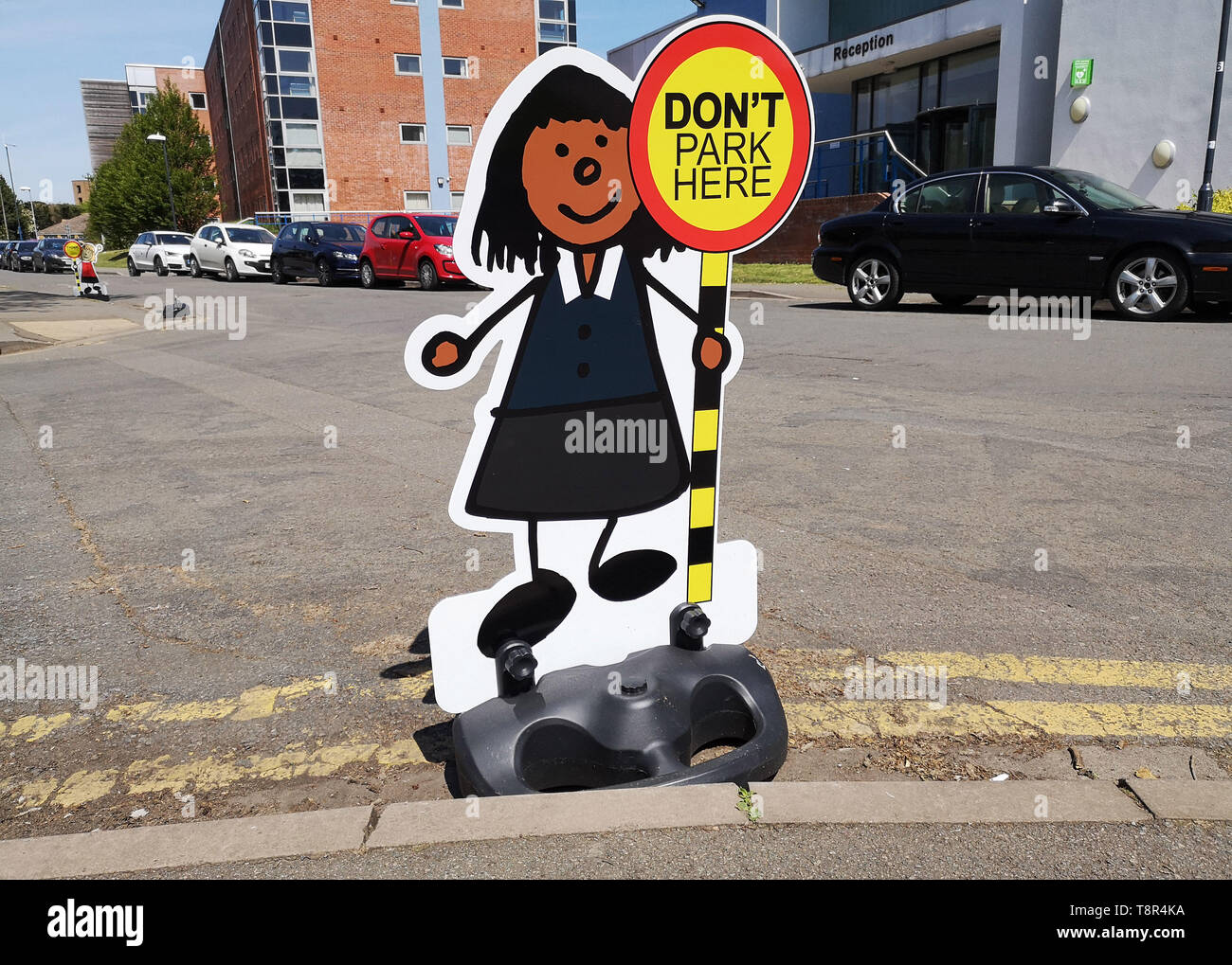 Traffic safety bollards that are drawings of small children are seen ...