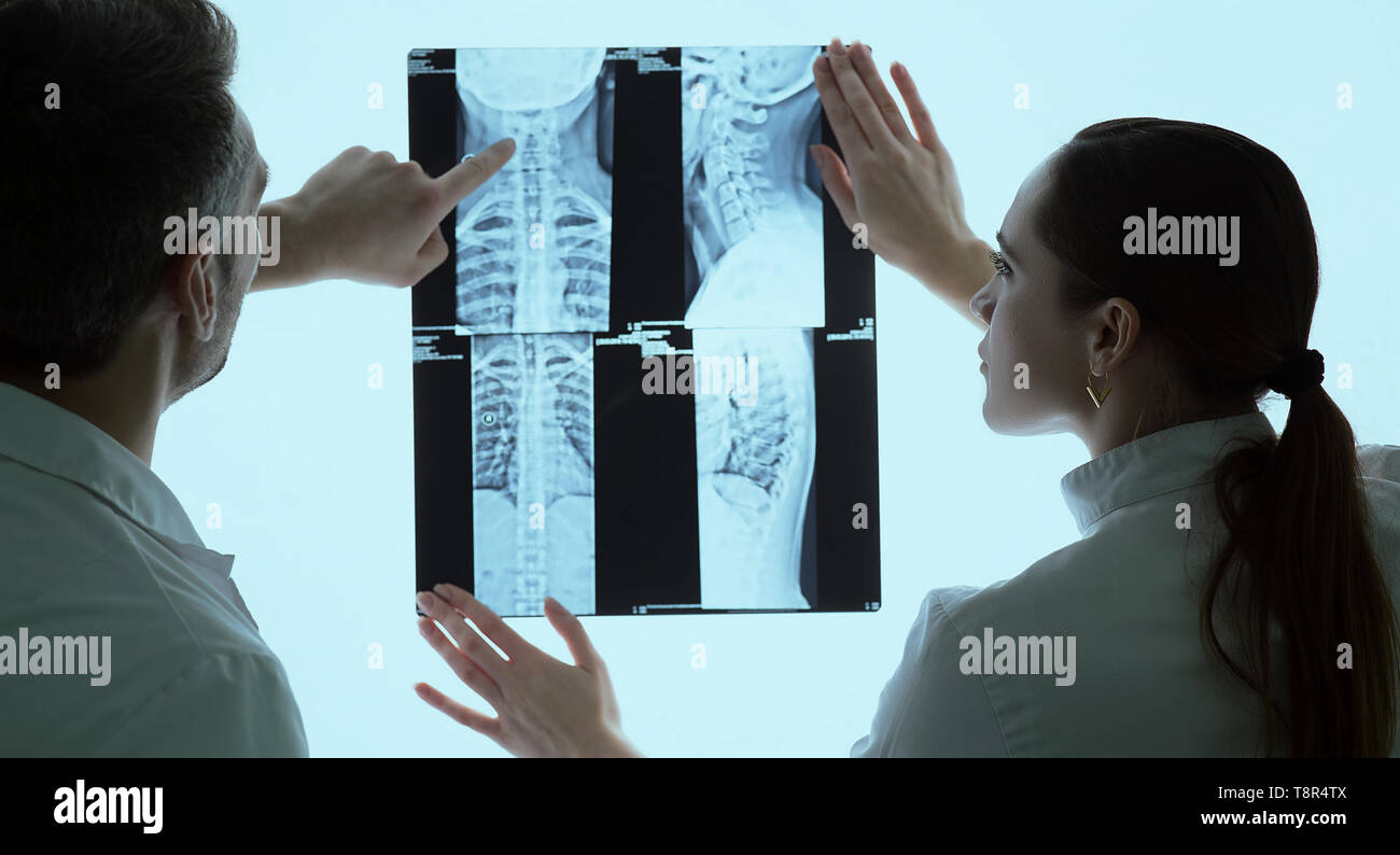 Two doctors discussing patients x-ray and MRI scans, chest x-rays Stock ...