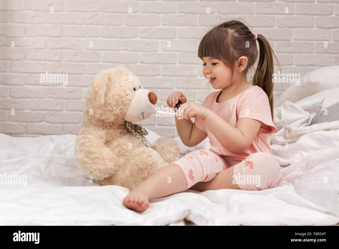 Cute Child Girl Playing Doctor With Teddy Bear At Home Stock Photo Alamy cute-child-girl-playing-doctor-with-teddy-bear-at-home-stock-photo-alamy