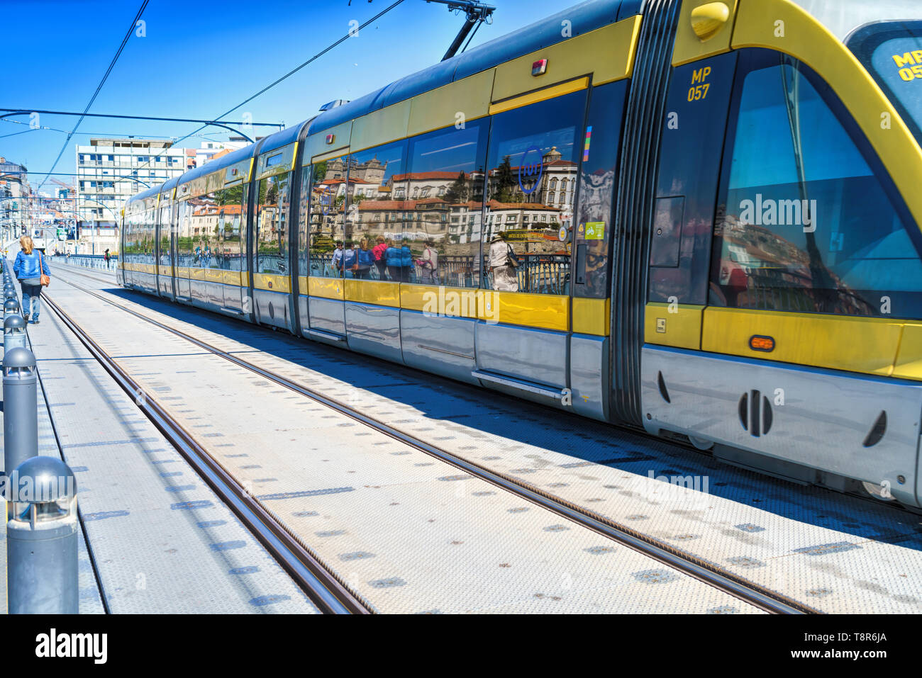 Modern light rail tram over the Dom Luis bridge in Porto city, Portugal ...