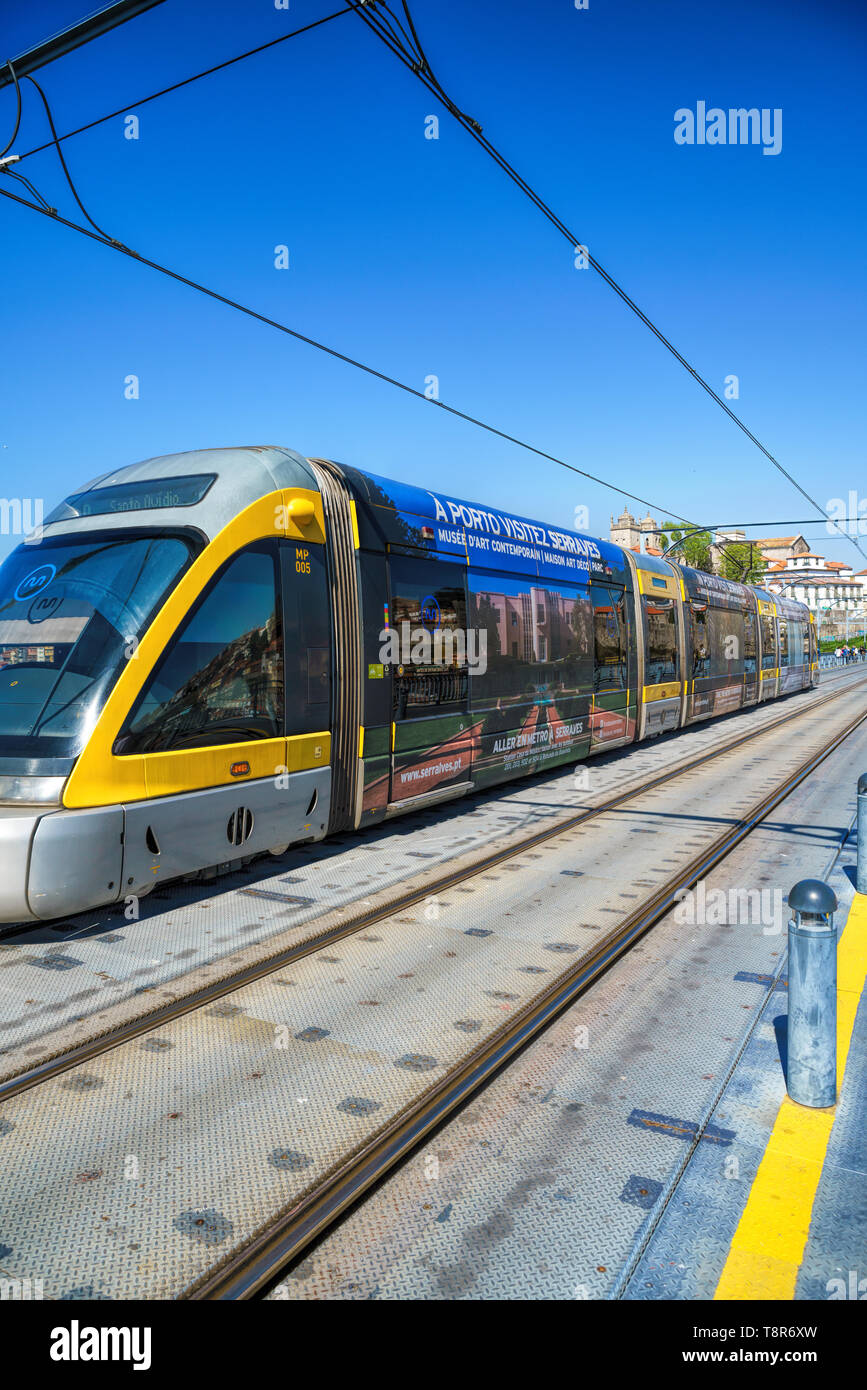 Modern light rail tram over the Dom Luis bridge in Porto city, Portugal ...