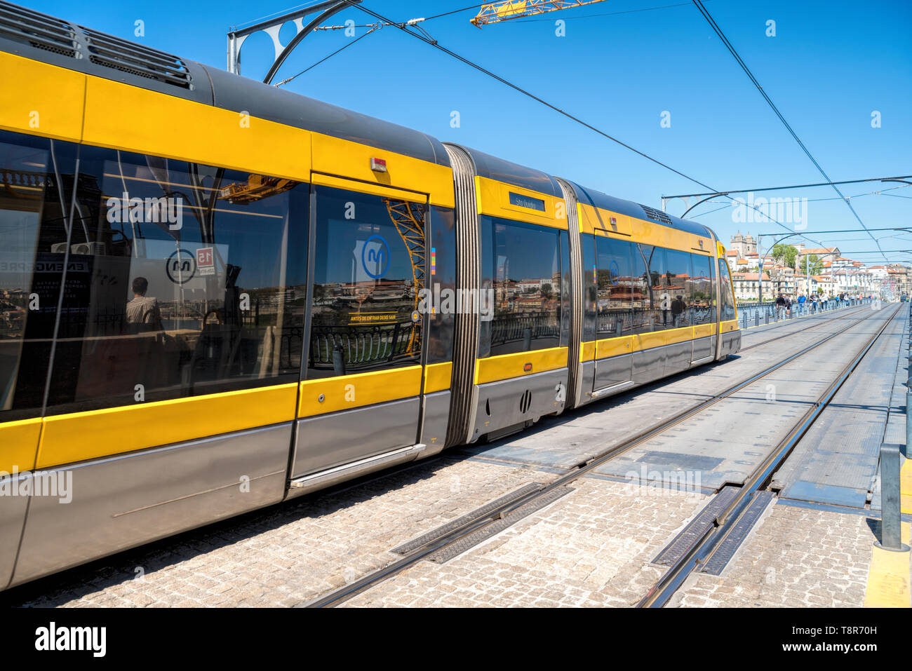 Modern light rail tram over the Dom Luis bridge in Porto city, Portugal ...