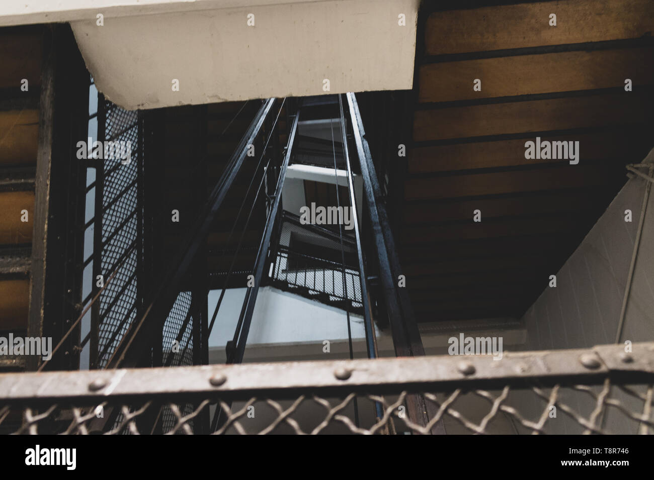 Vertigo stairs without light on the end Stock Photo - Alamy