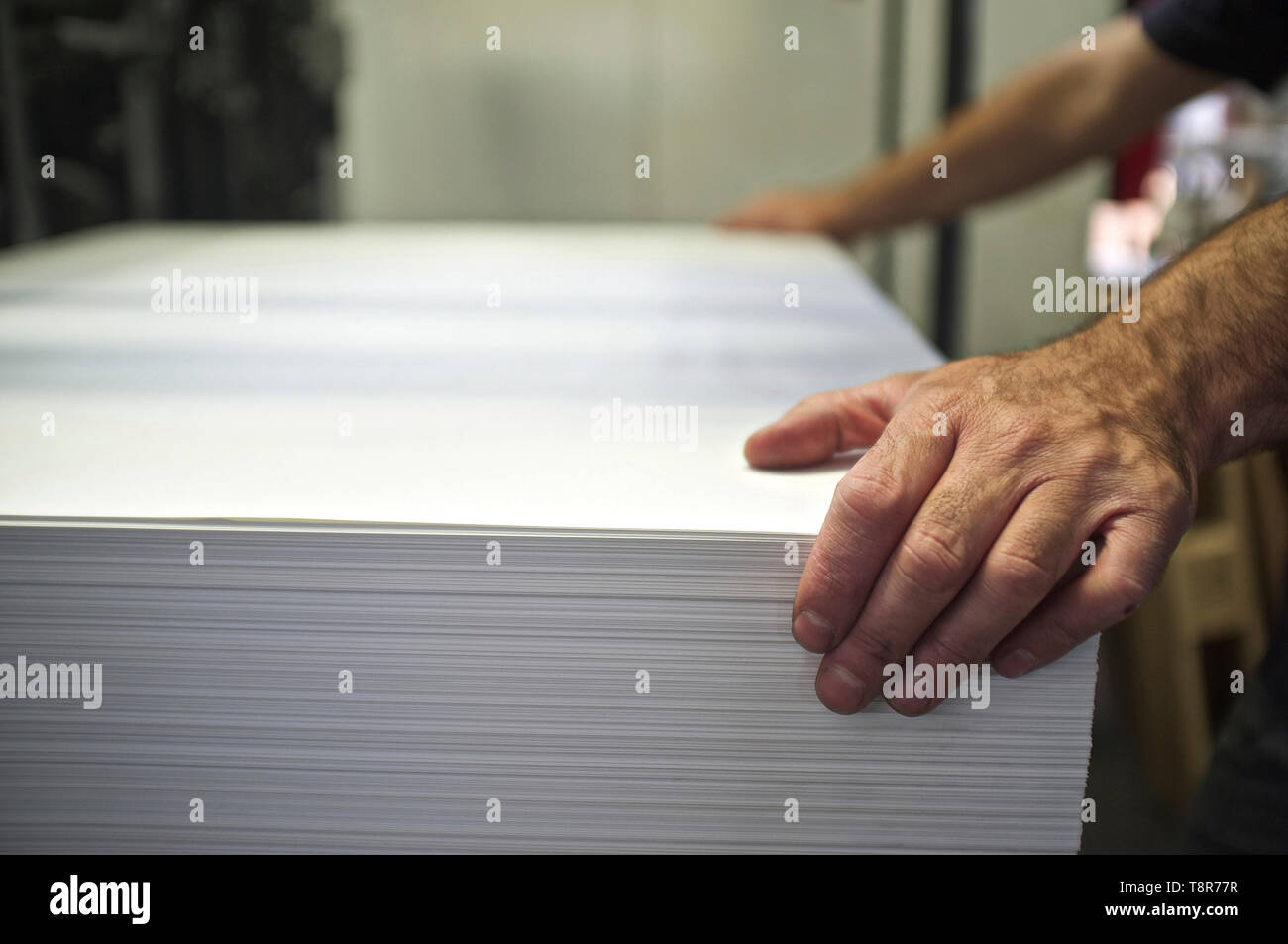 close-up of manually loading paper offset printing machine Stock Photo ...