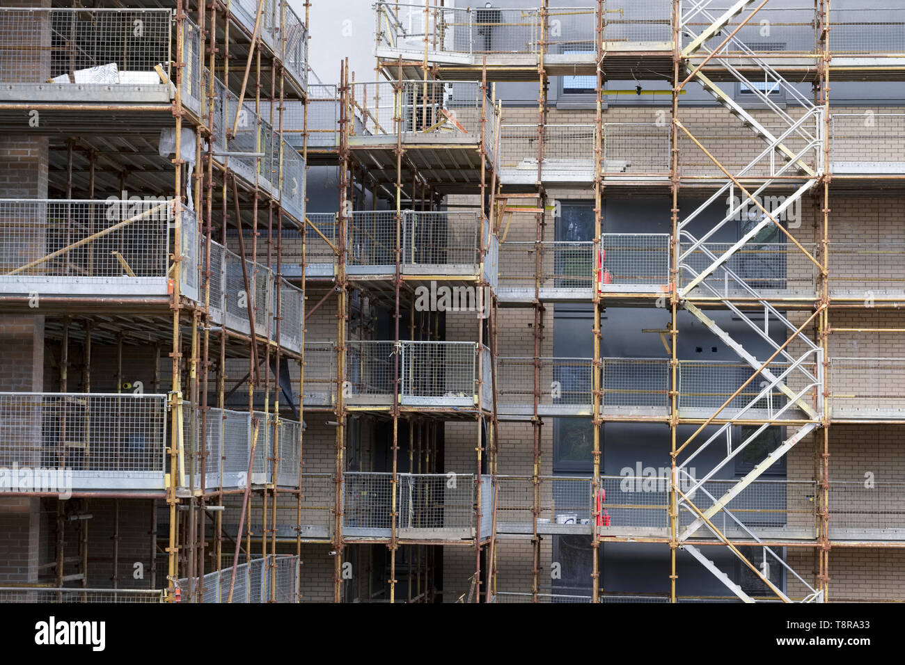 Construction building site close up of scaffolding poles and stair ...