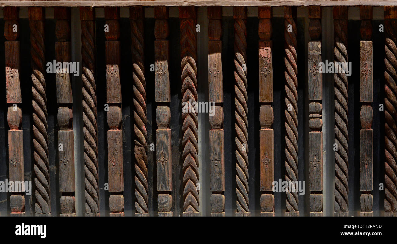Salvaged decorative turned posts serve as security bars in an historic ...