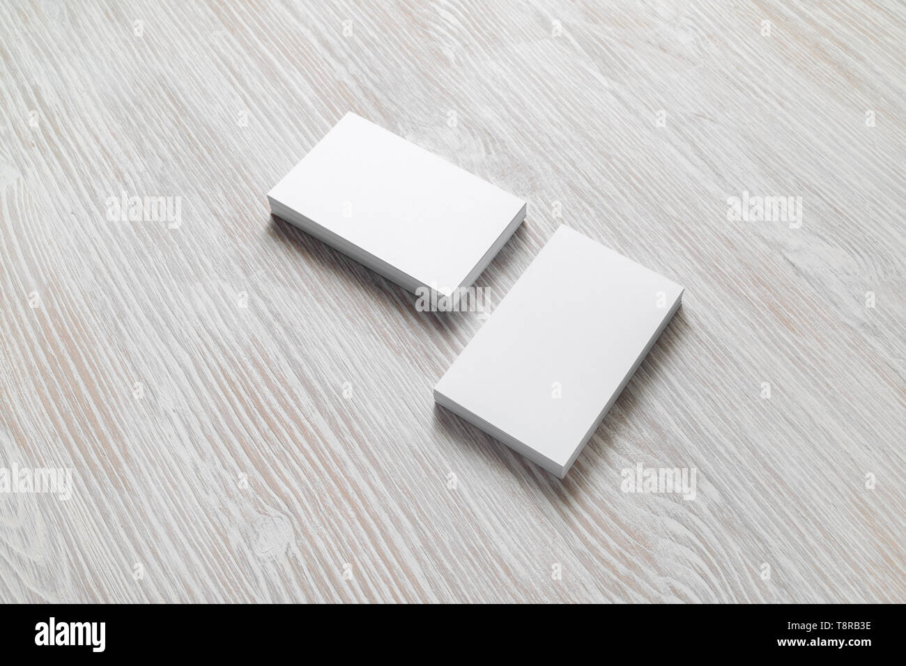 Blank business cards on light wood table background. Template for ID ...