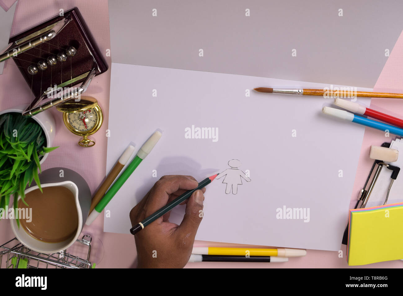 Top view of the man's hands drawing on a pink table, preparing to do ...