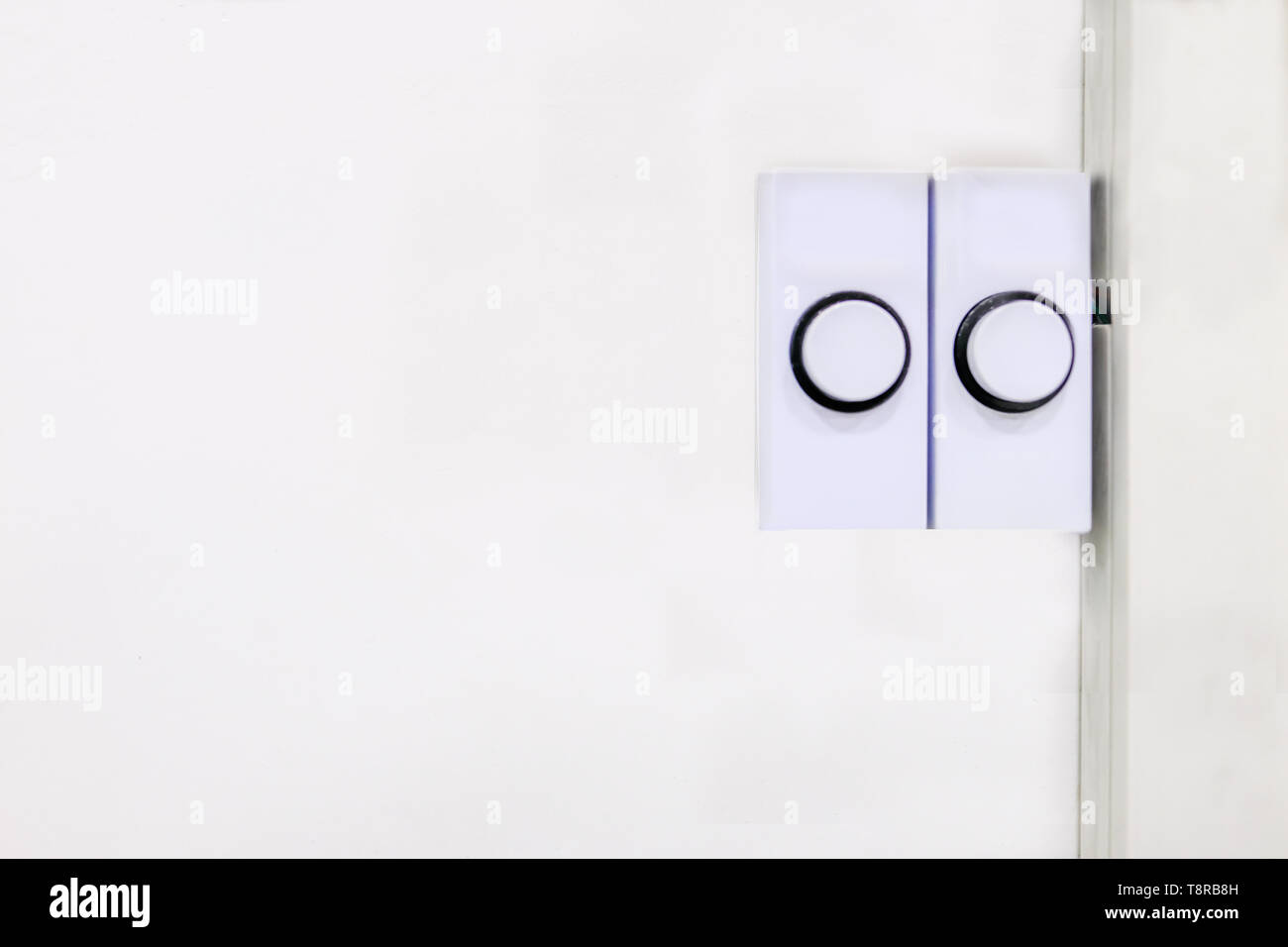 Two white plastic rectangular door bell buttons ready for pushing to ...