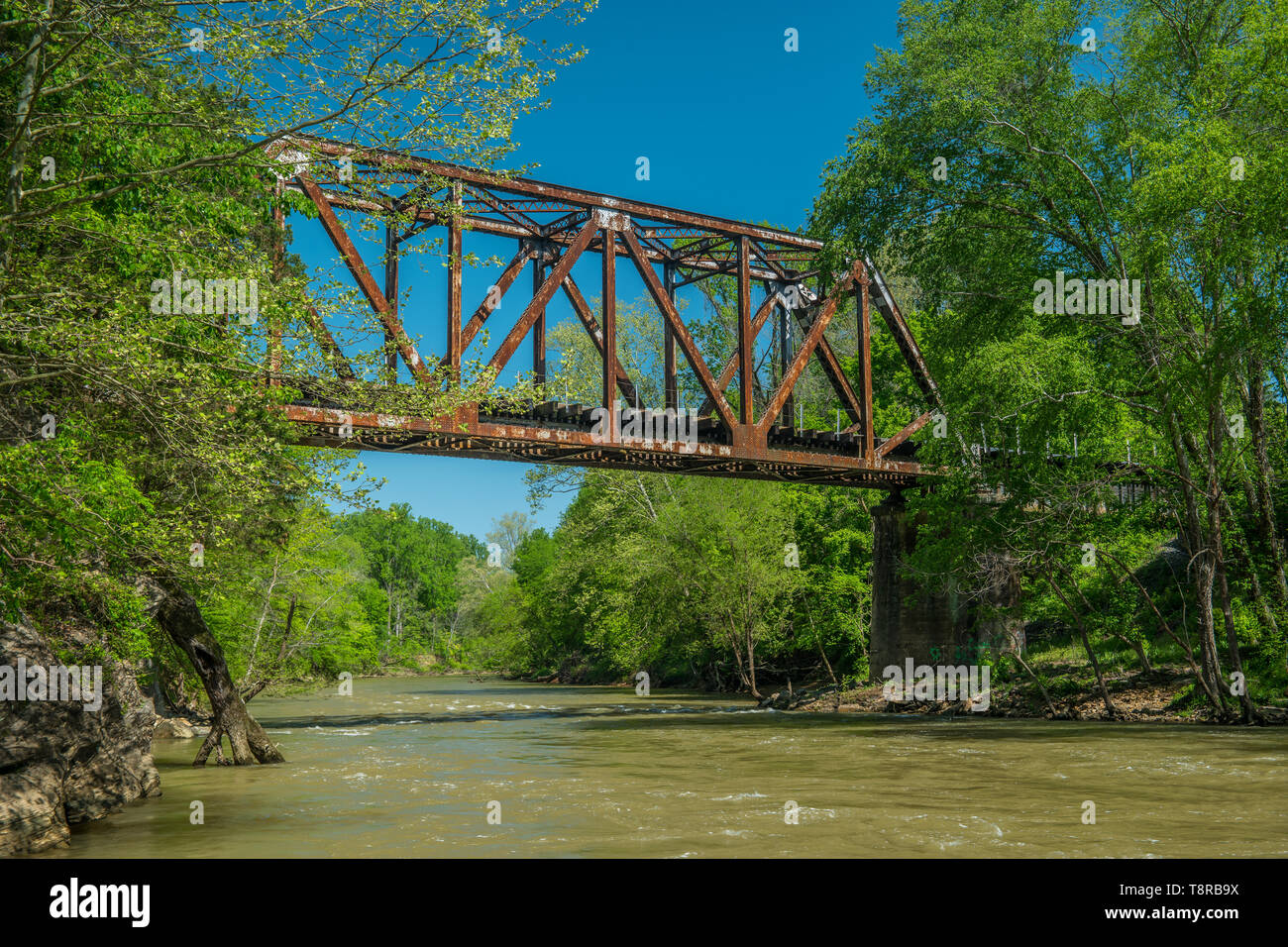 Old rusty train trestle over a fast flowing river Stock Photo - Alamy