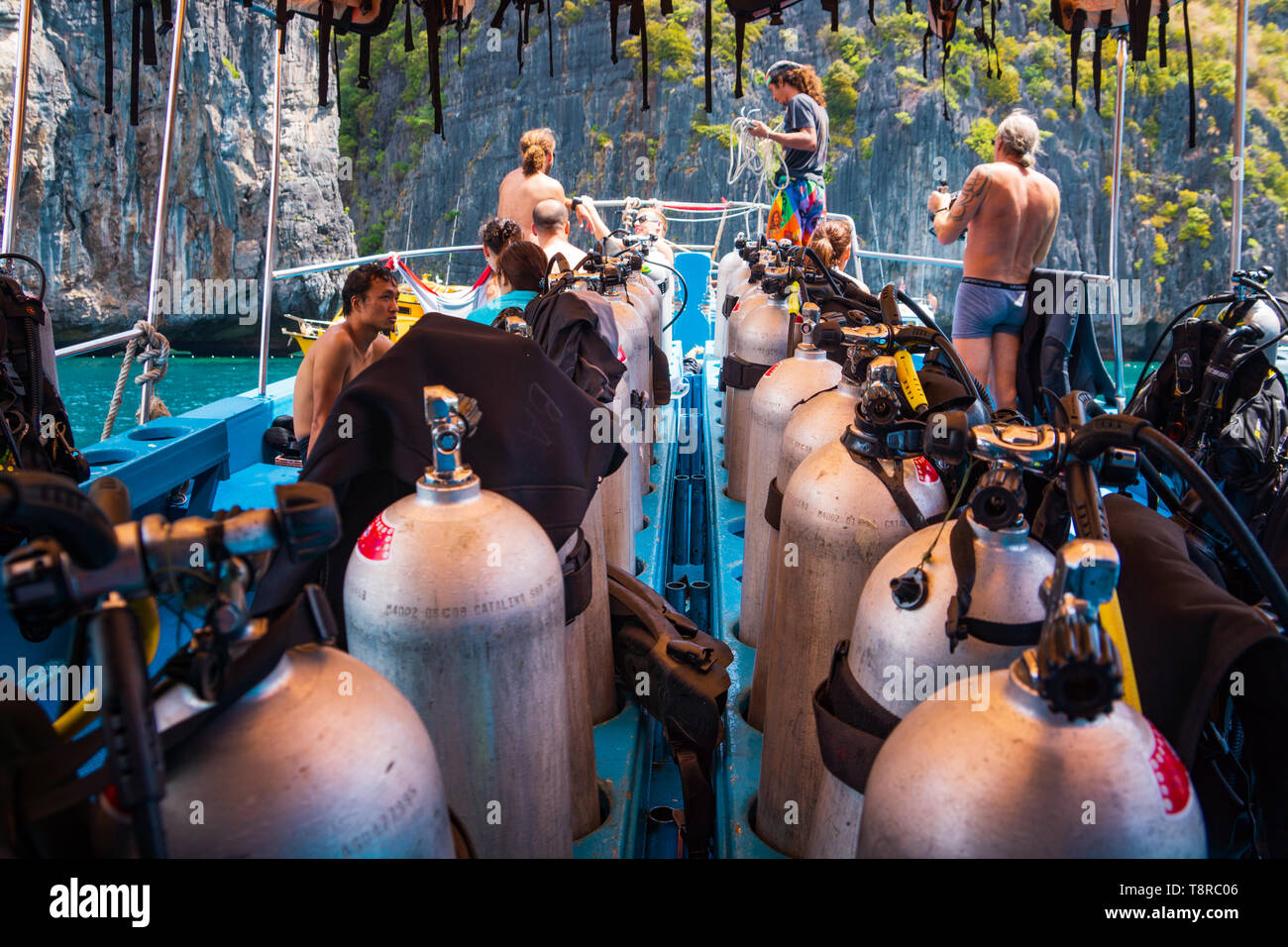 Scuba divers getting ready for diving on a boat full of equipment ...