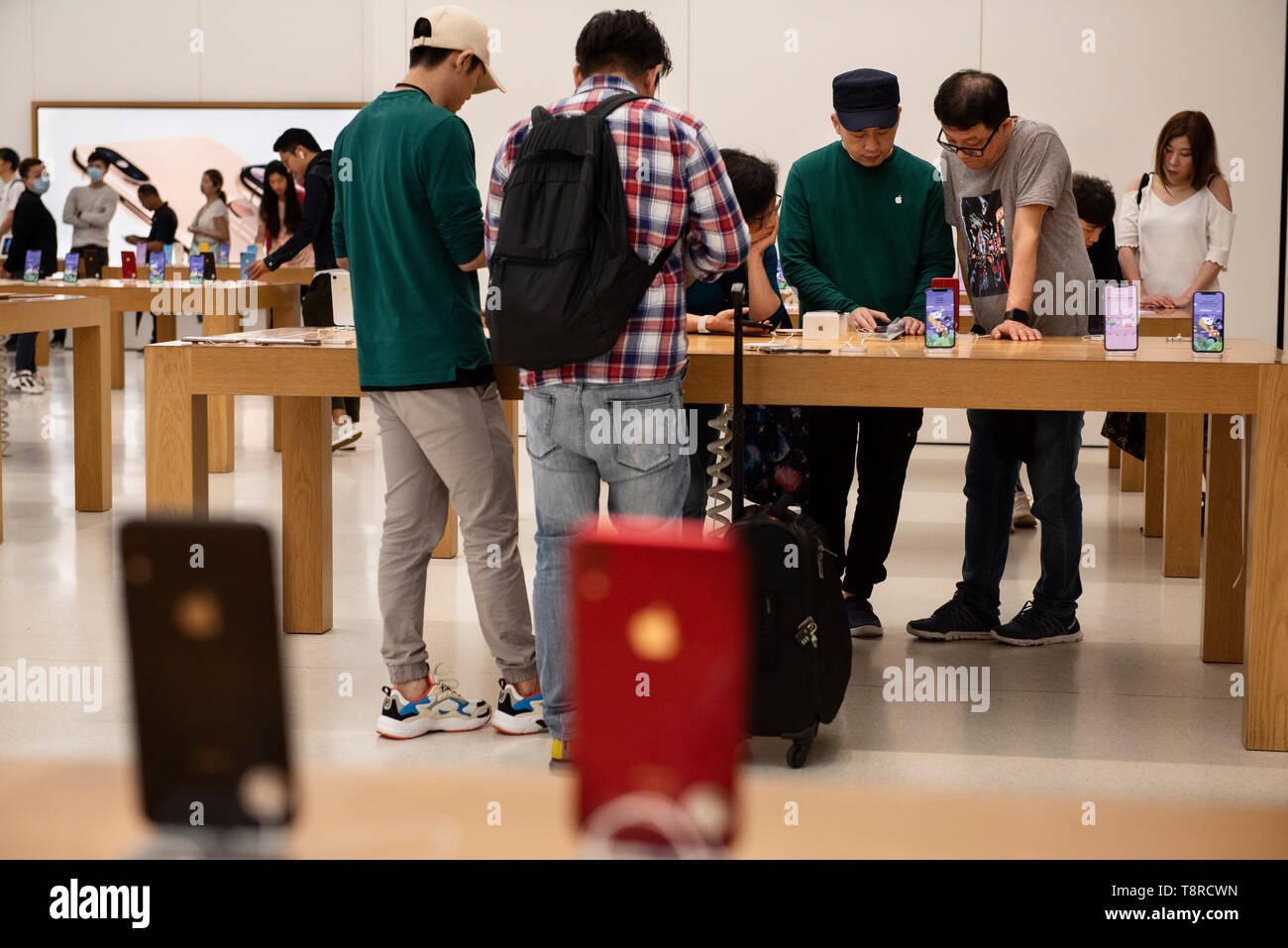 Apple employees seen assisting clients at the American multinational ...