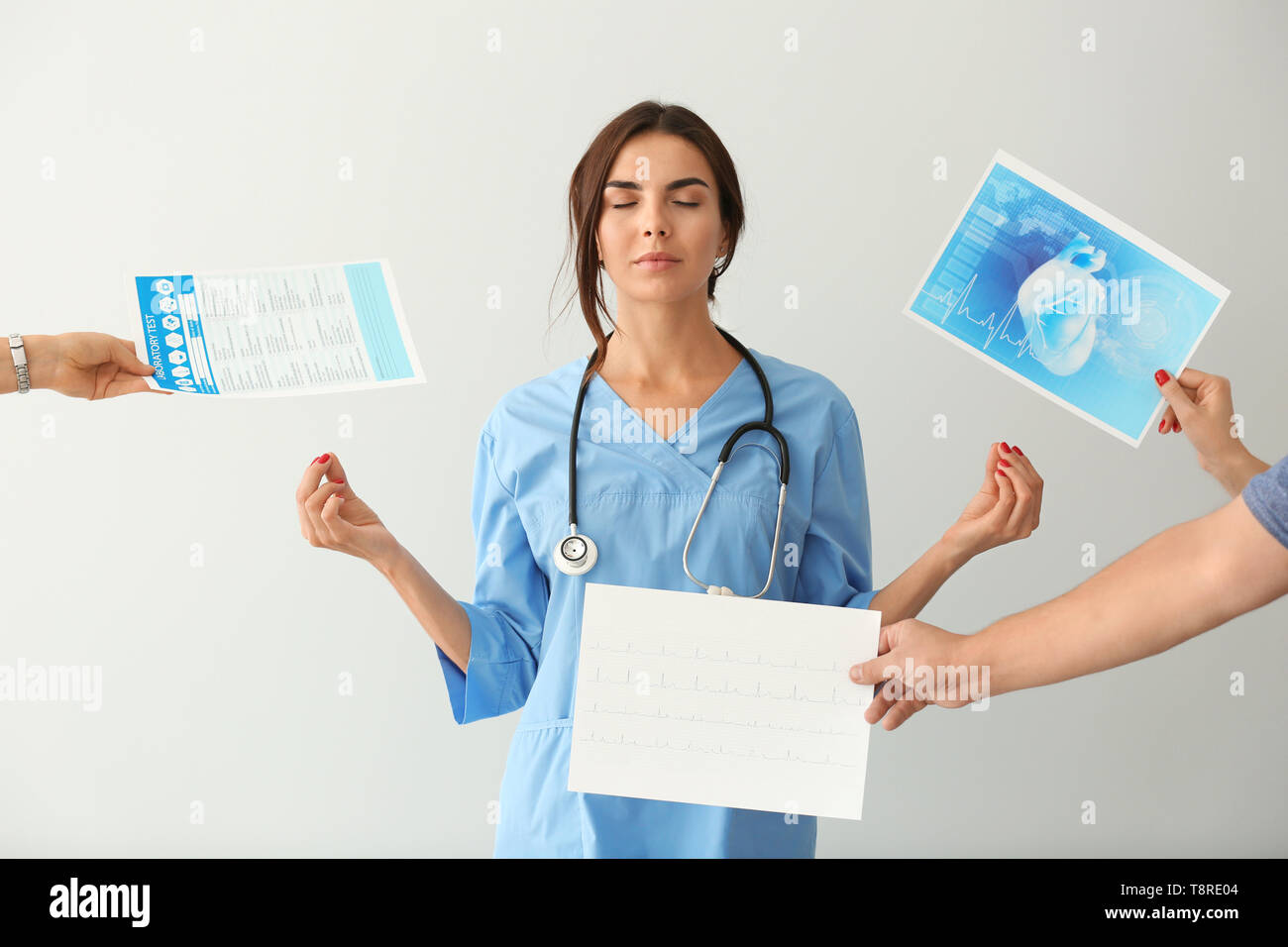Female nurse with lot of work meditating on light background Stock ...