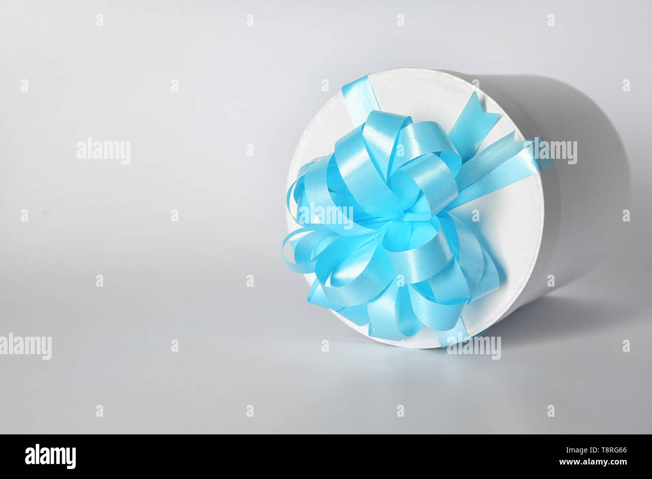 Gift box with blue ribbon on white background Stock Photo - Alamy