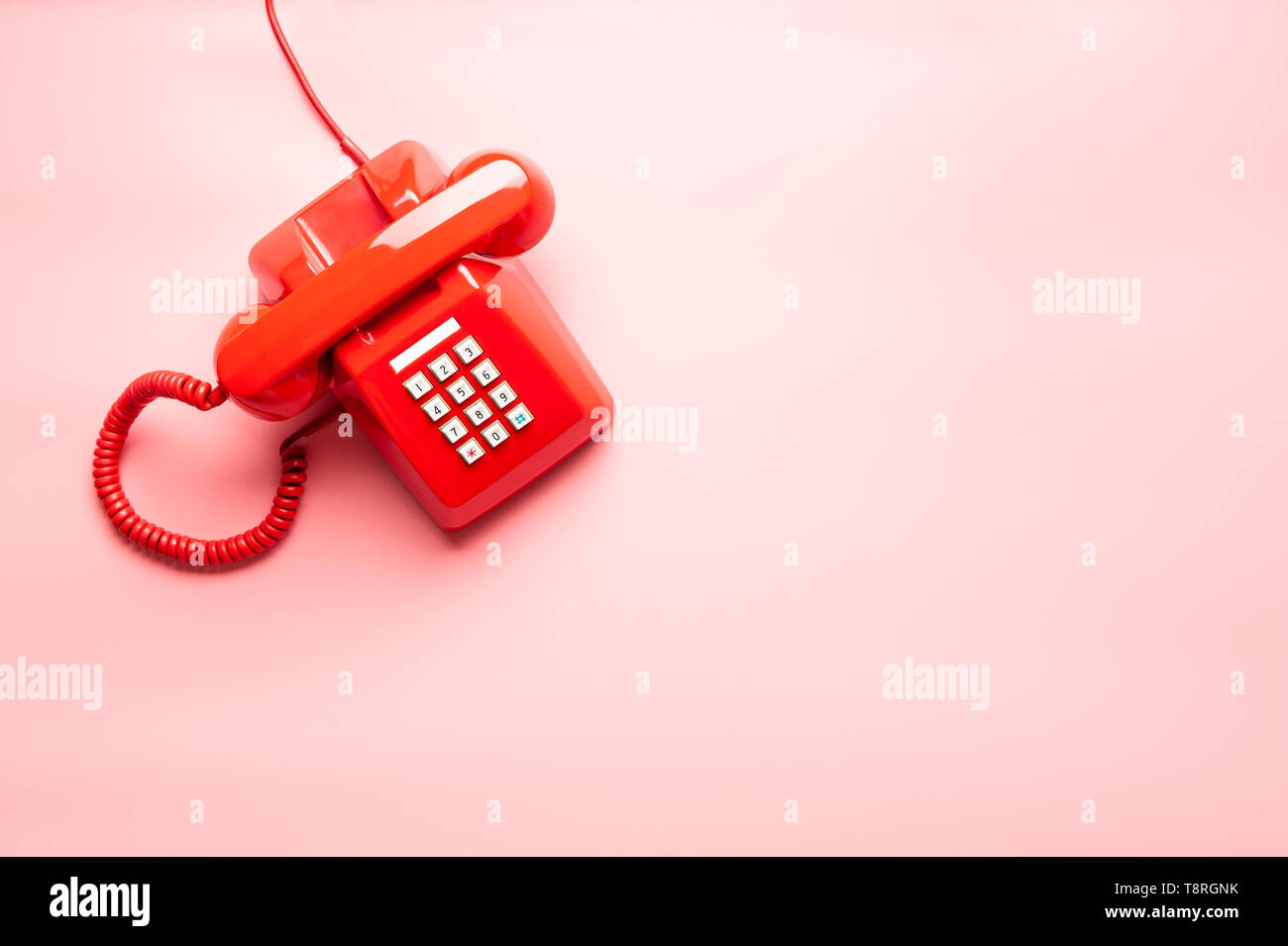 Top view of red telephone on pink desk or background, waiting phone ...