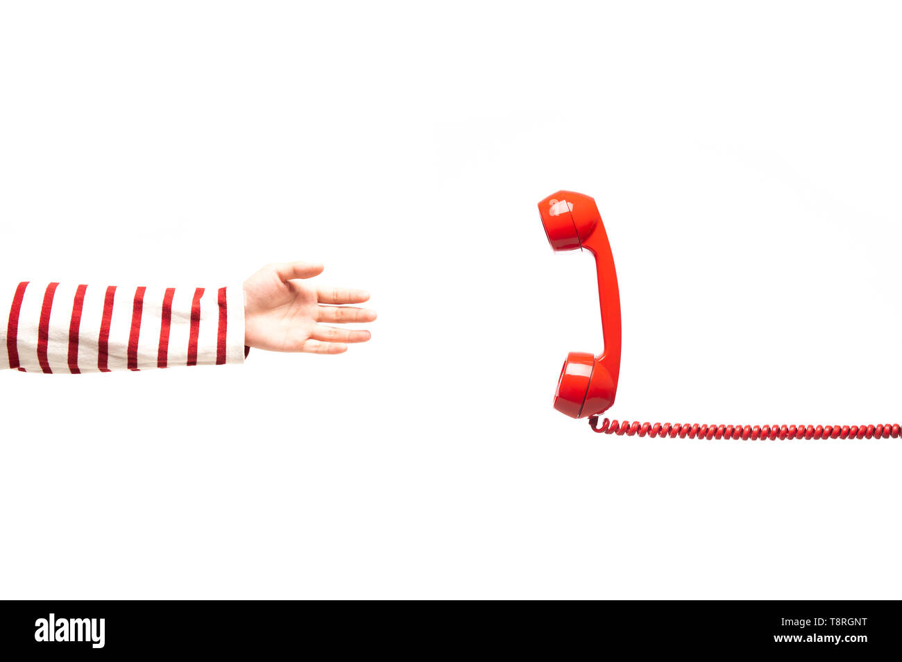 Hand reaching to the red telephone, phone calling isolated on white ...