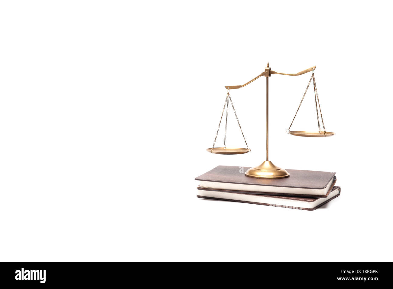 Gold brass balance scale placed on the vintage books isolated on white ...