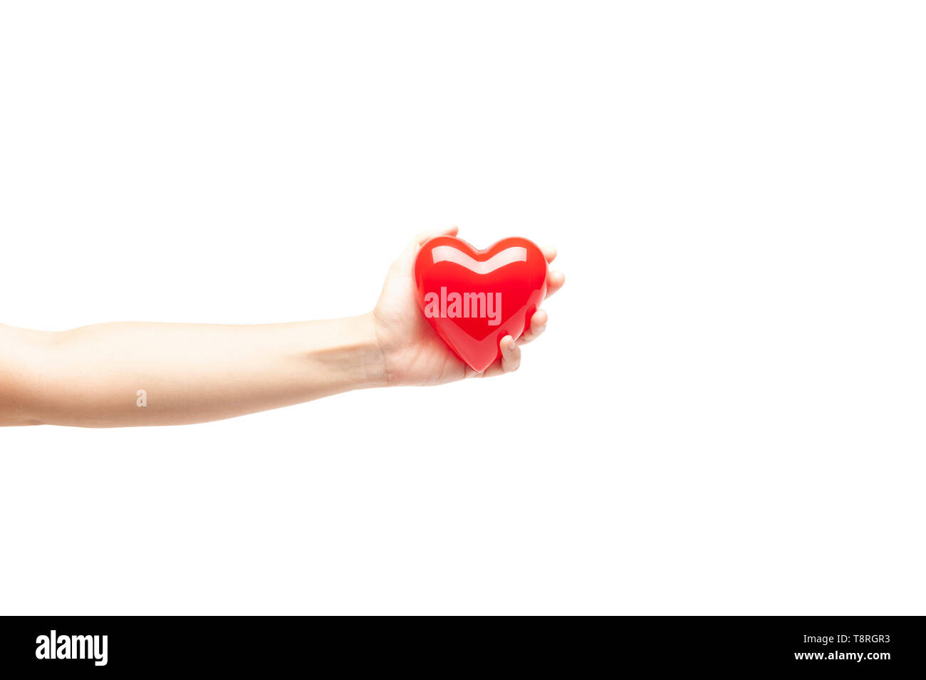 Hand holding plastic red heart isolated on white background, giving red ...
