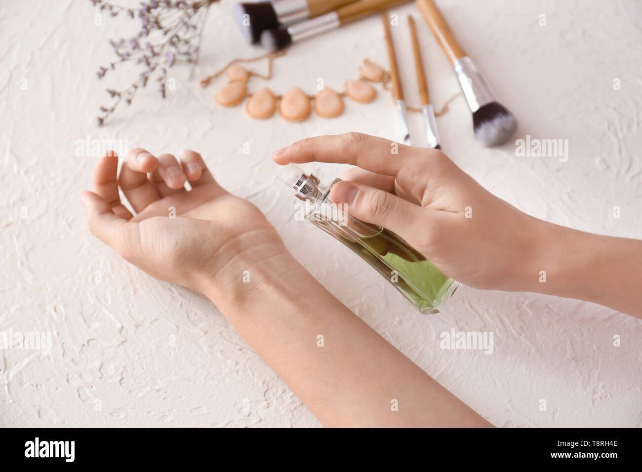 Beautiful woman applying perfume hi-res stock photography and images ...