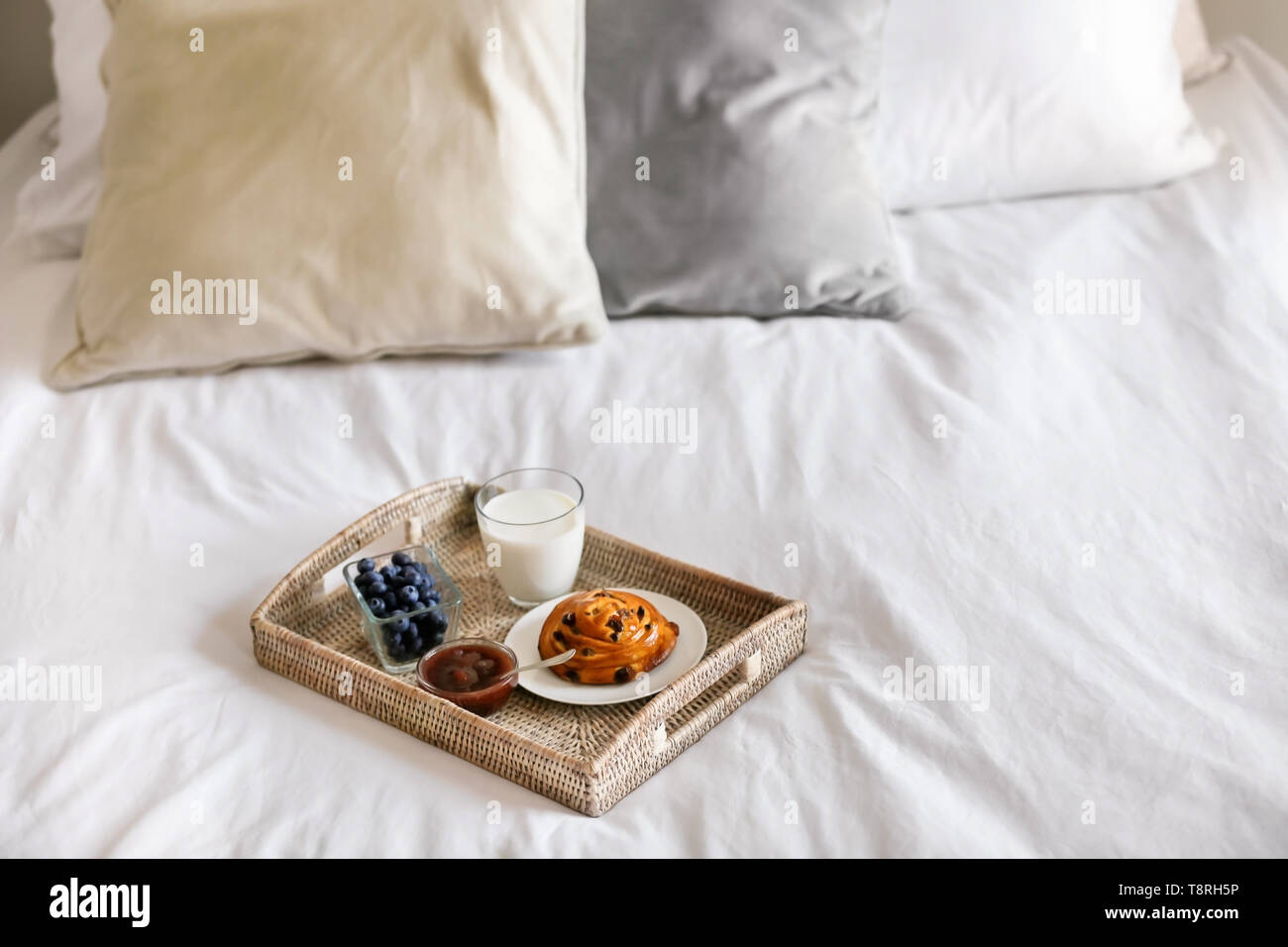 Tray with delicious breakfast on bed Stock Photo - Alamy