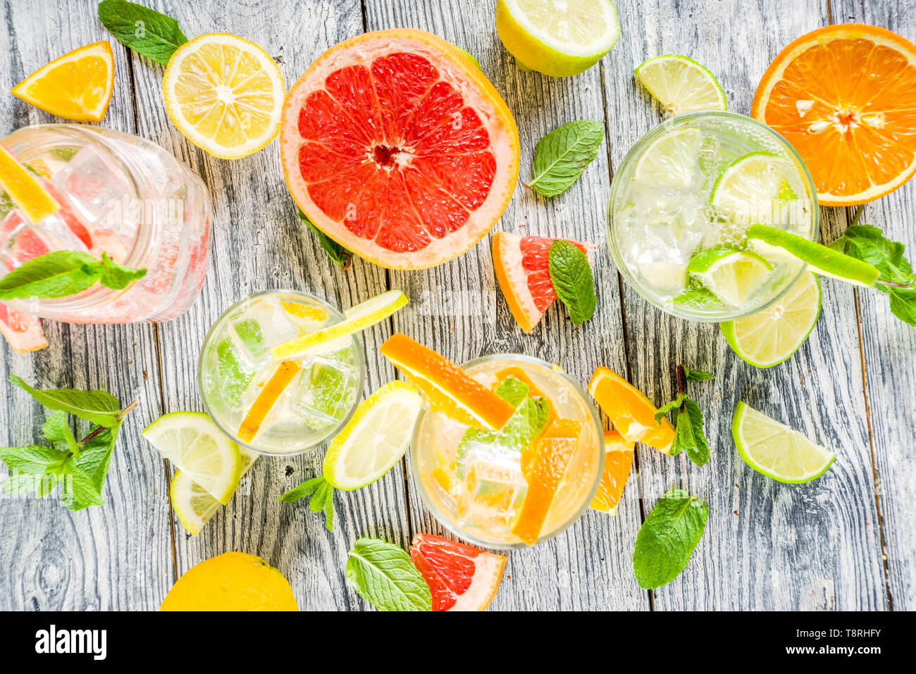Summer refreshment drinks. Four types of citrus lemonade or mojito ...