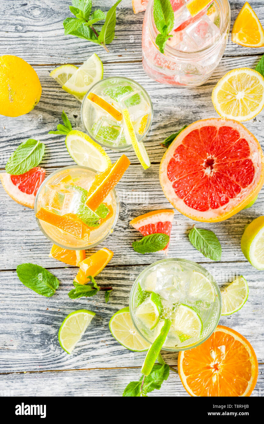 Summer refreshment drinks. Four types of citrus lemonade or mojito ...