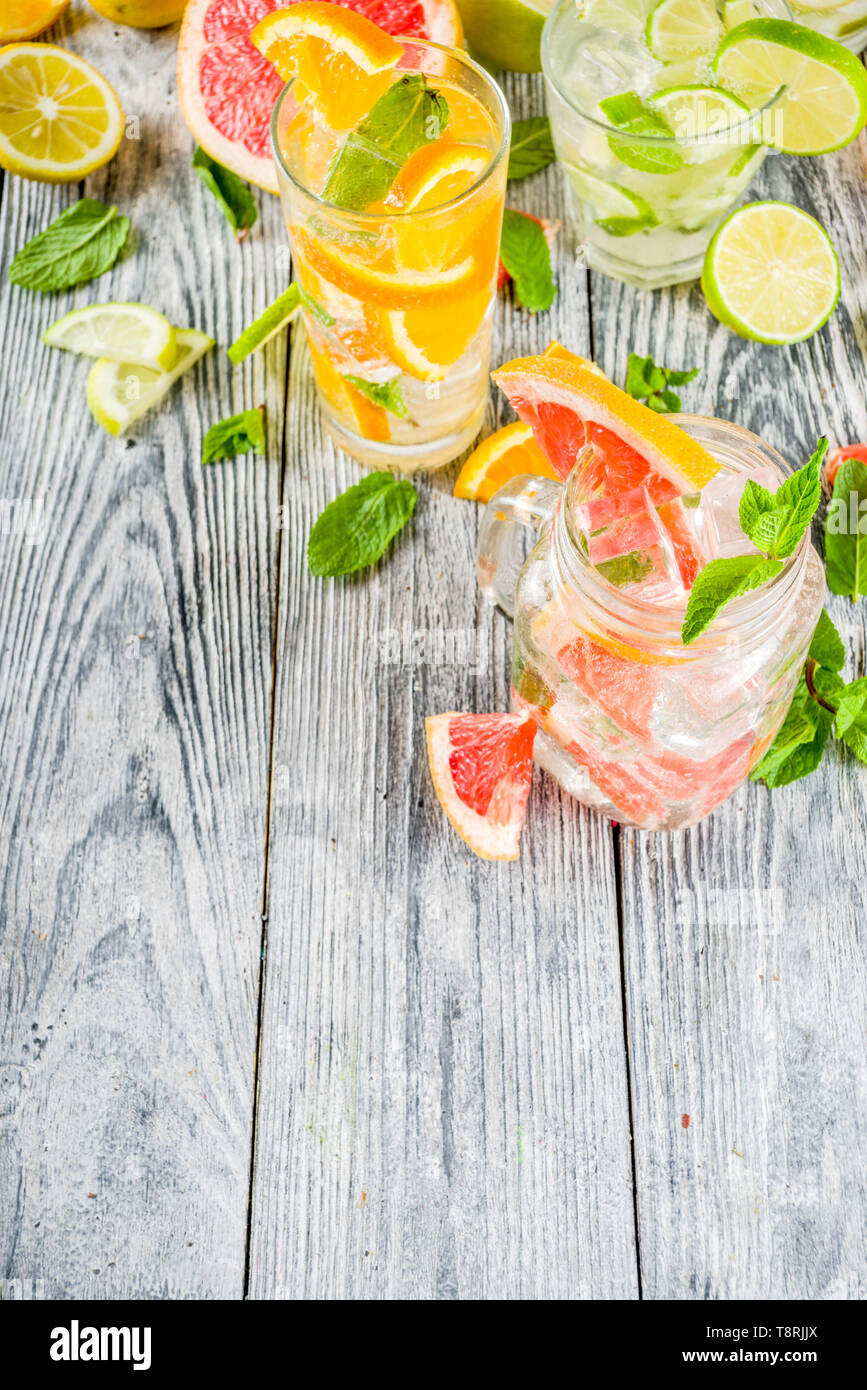 Summer refreshment drinks. Four types of citrus lemonade or mojito ...