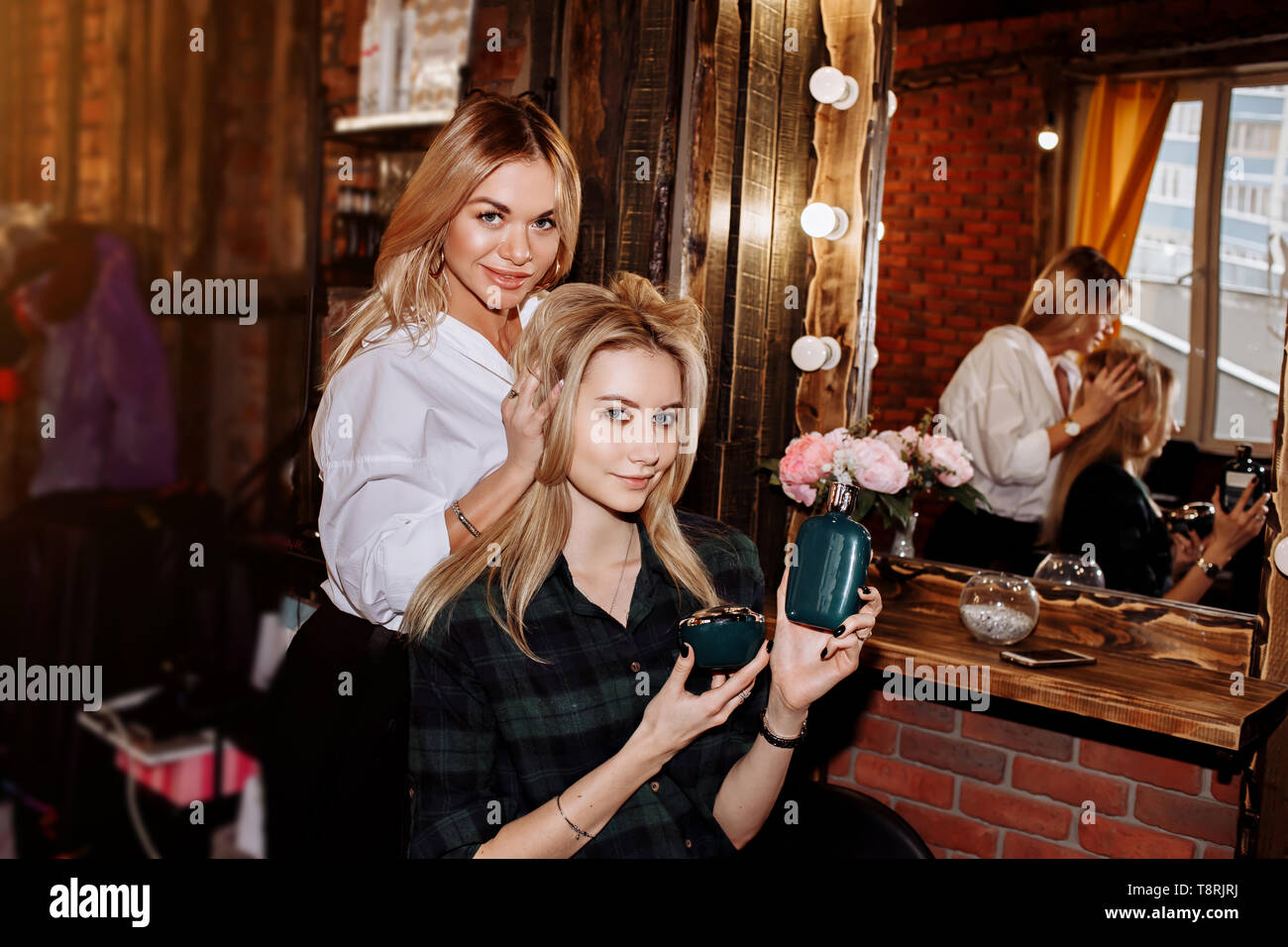 Beautiful hairstyle of young woman after dyeing hair in beauty salon ...