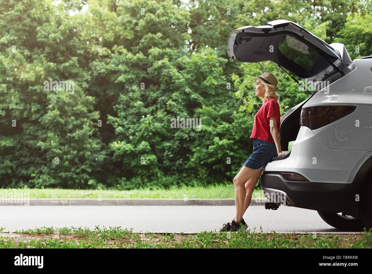 Girl standing near car on road Stock Photo - Alamy