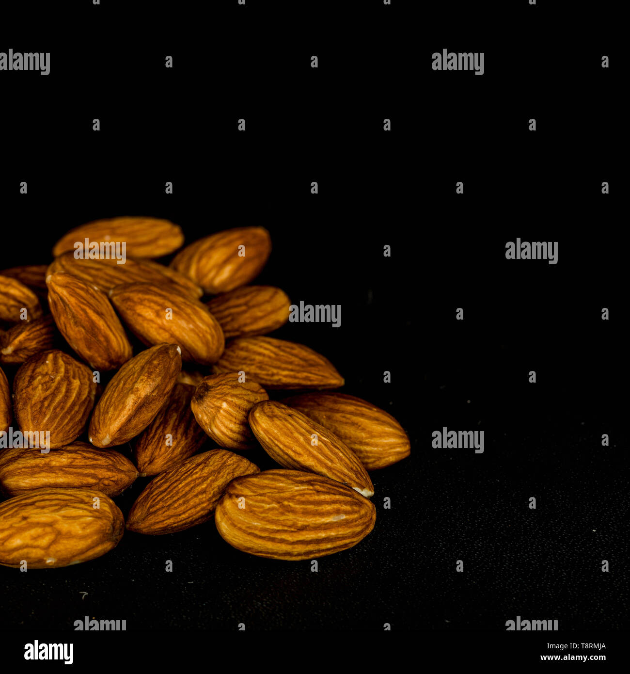 Handful of Almond Nuts on a BLack Background Stock Photo - Alamy