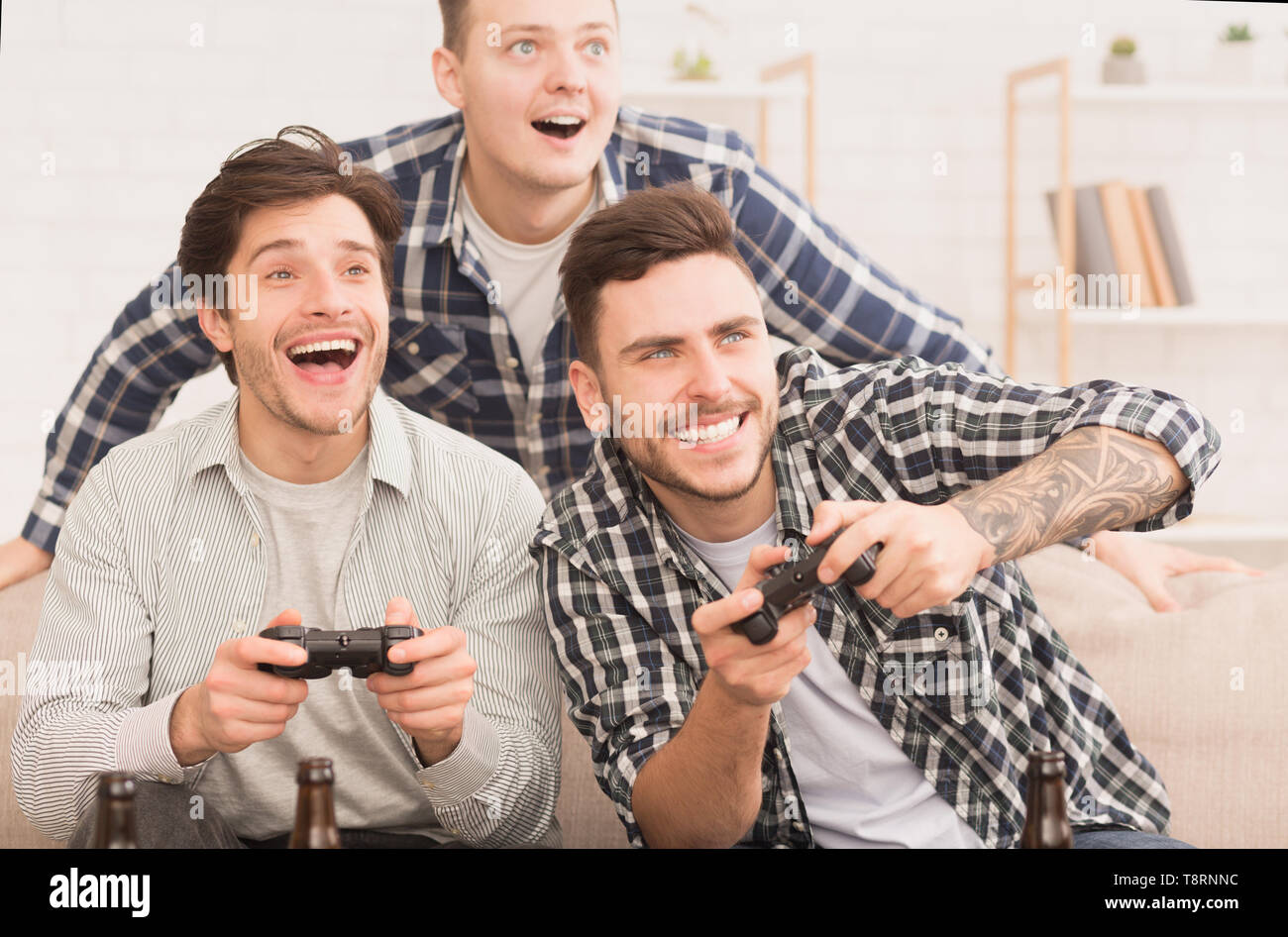 Gamers. Happy Friends Playing Video Games At Home Stock Photo - Alamy
