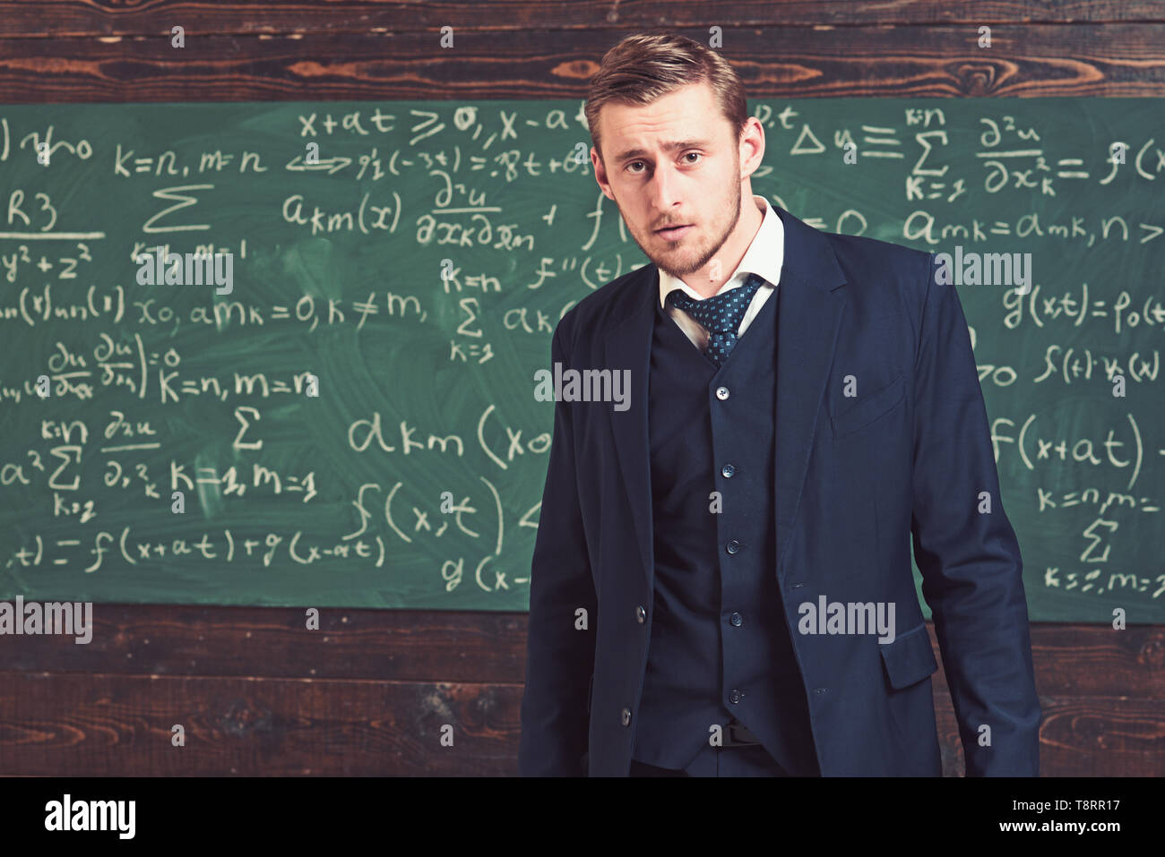 Intelligent man in suit standing in classroom. Aristocrats and elite ...