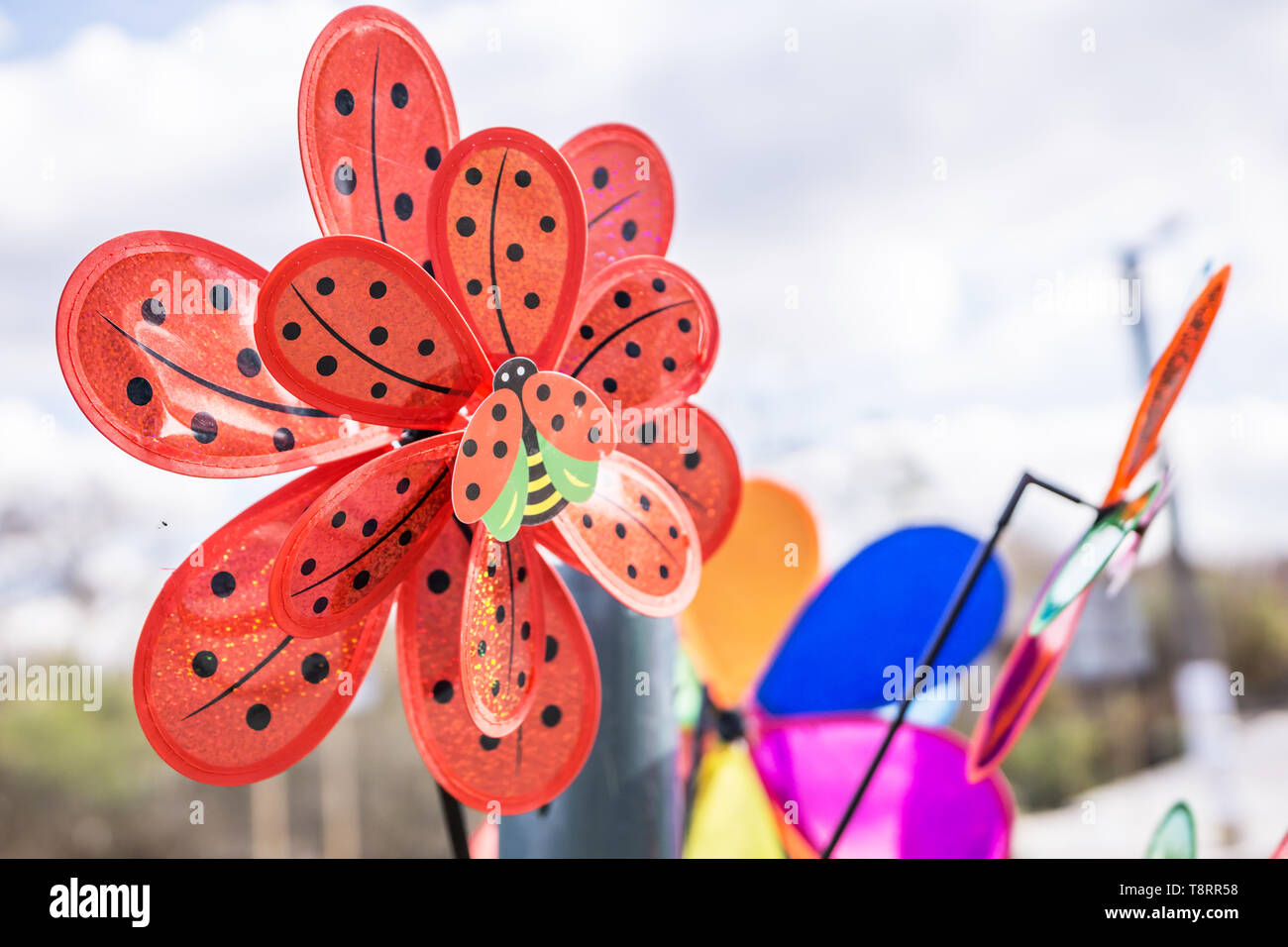 Close-up of a garden decoration, a carousel with colored glitter wings ...