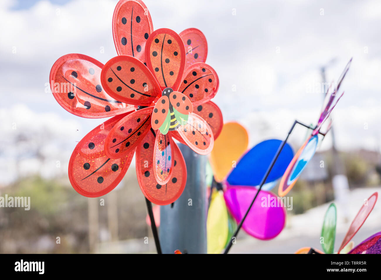 Close-up of a garden decoration, a carousel with colored glitter wings ...
