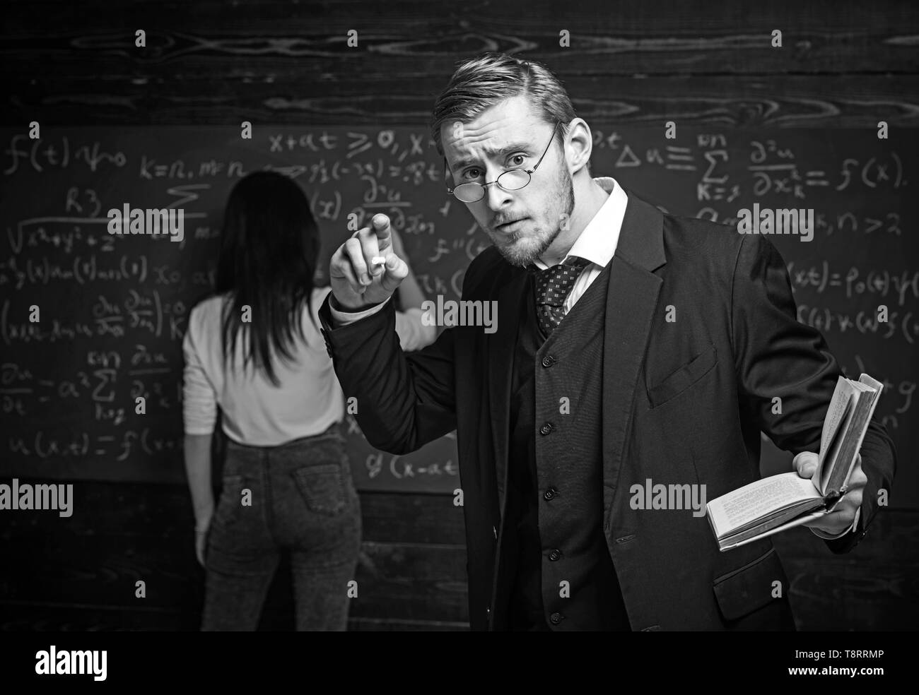 Agitated young professor passionately explaining mathematic formula ...