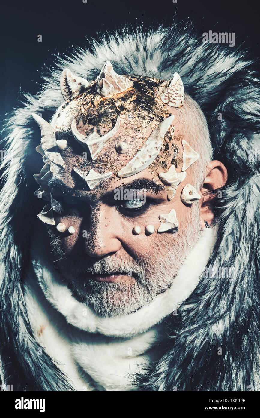 Senior man with white beard dressed like monster. Alien, demon ...